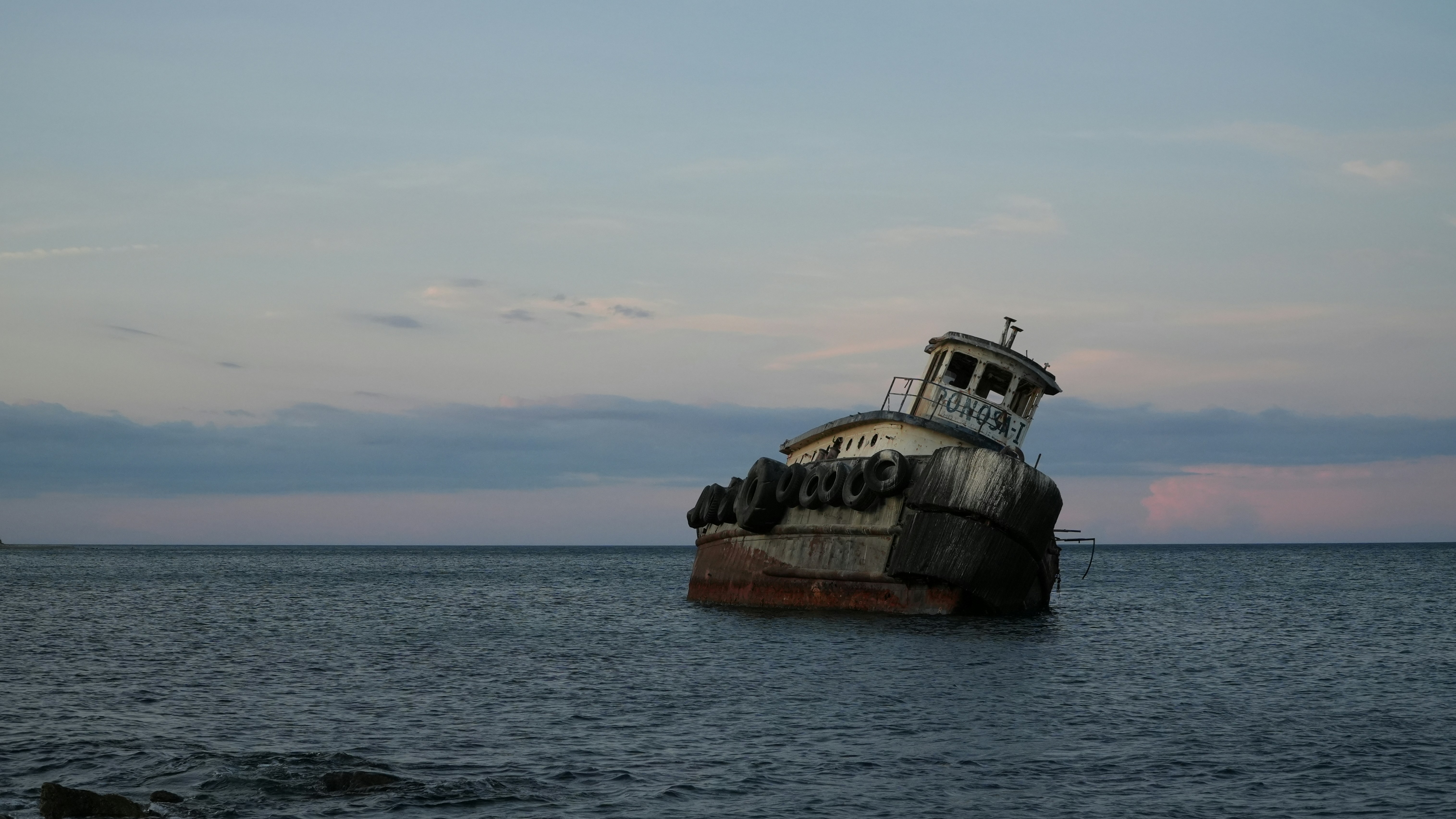 Nestled Vessel at Dusk: A Resting Ghost of the Sea