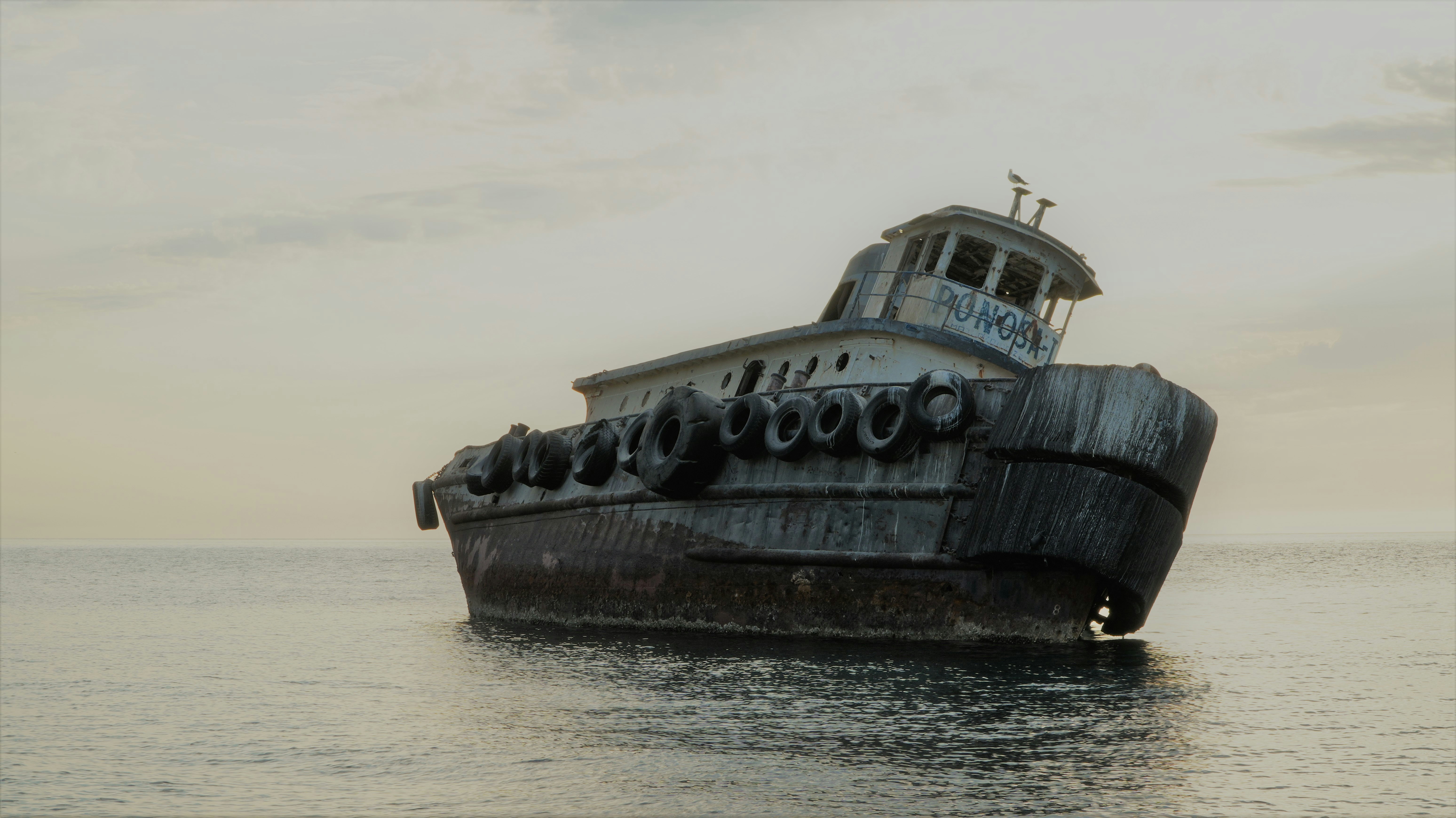 Worn Vessel Resting on Calm Horizon