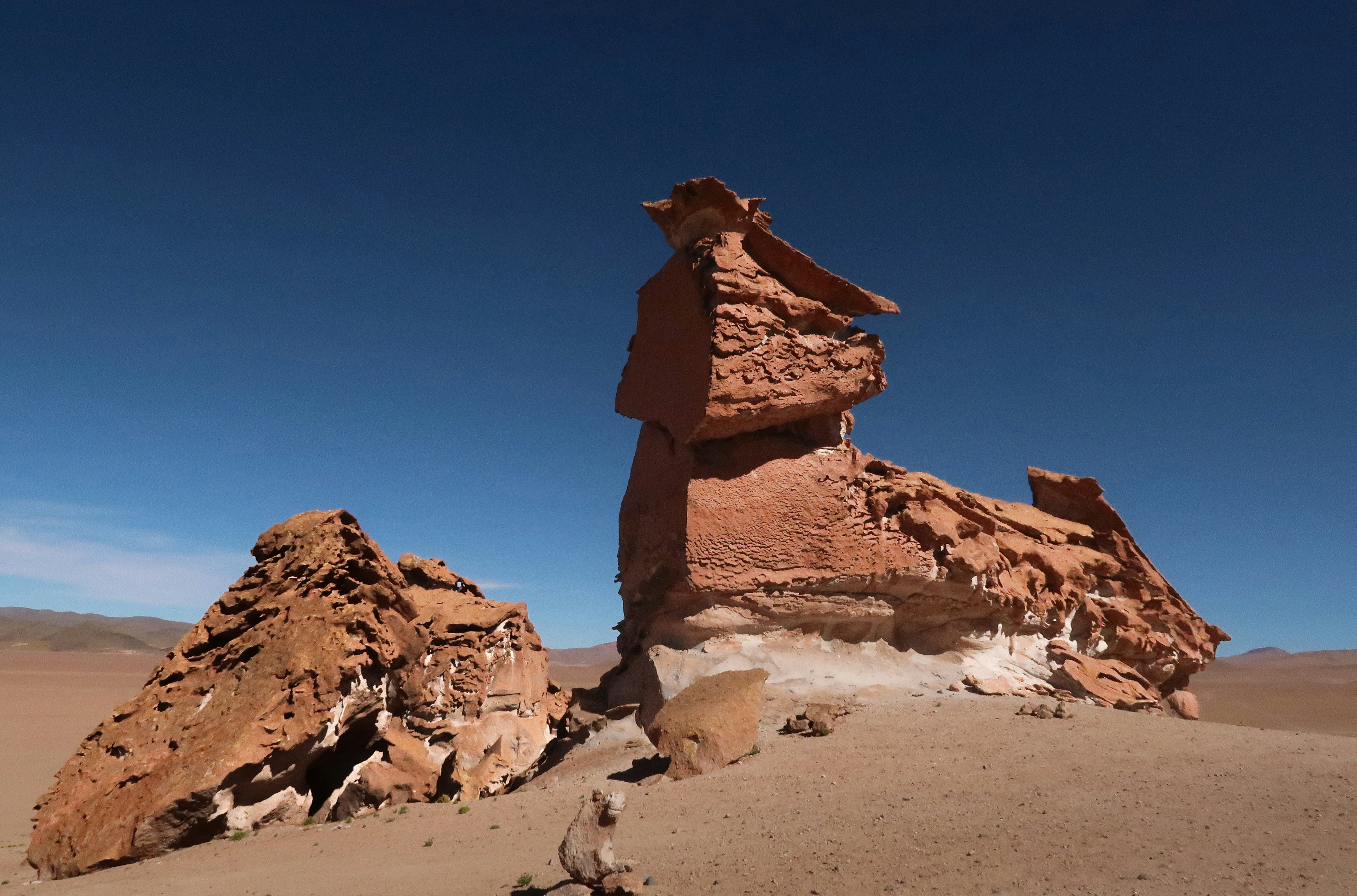 Stone Sentinel in a Sunlit Desert Expanse
