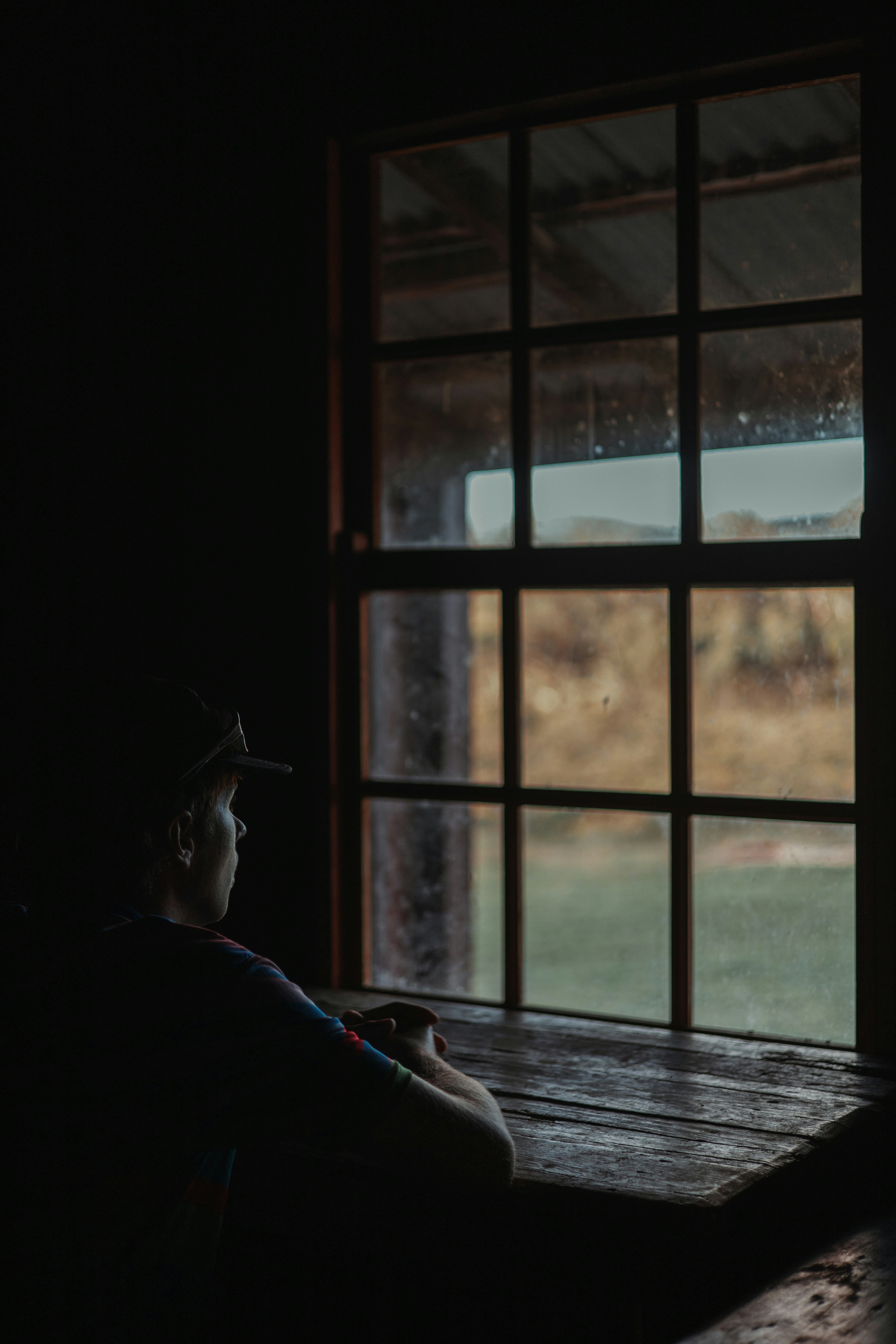 Waiting by the Window: A Quiet Portrait in Dim Light