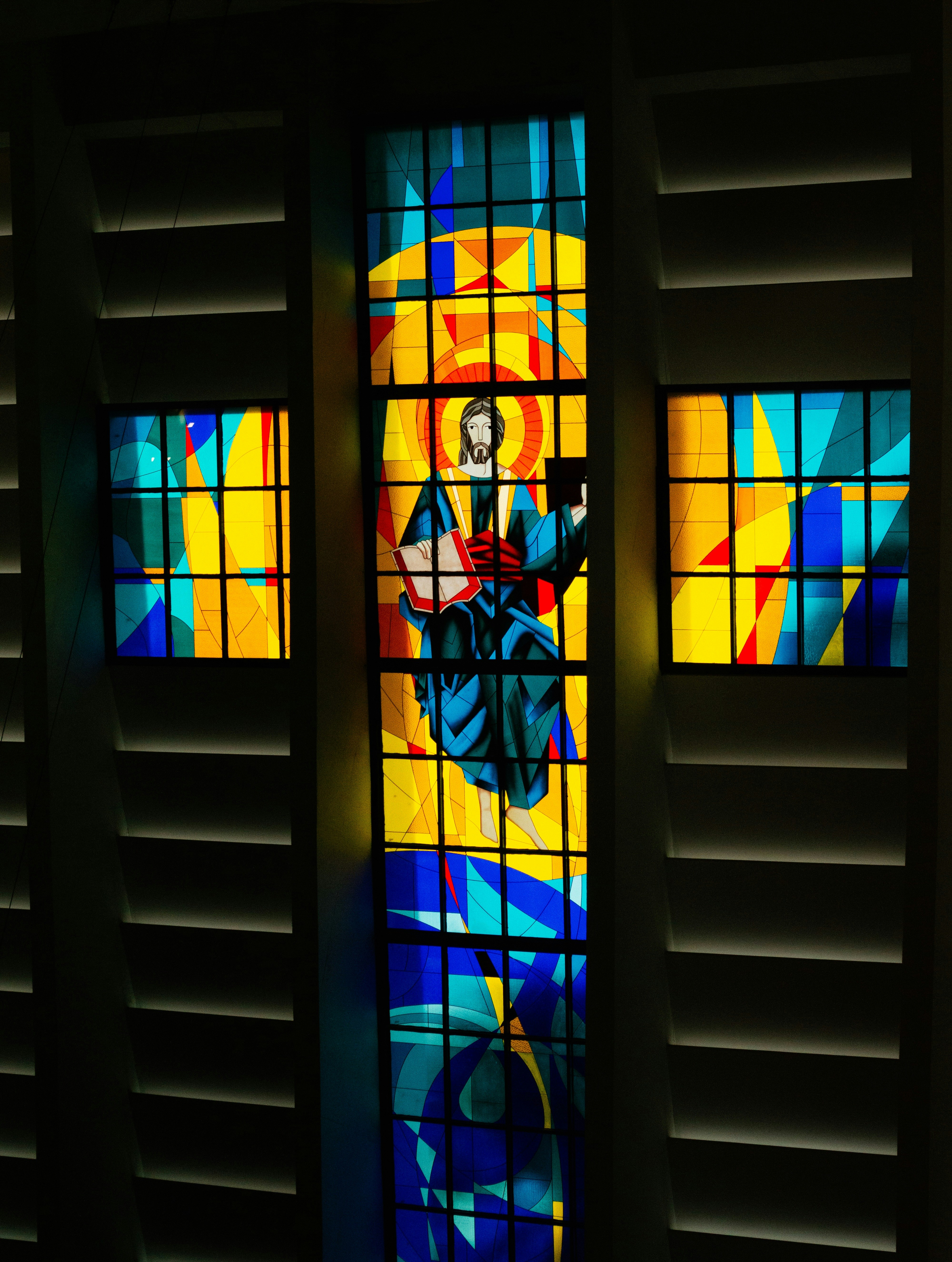 Stained Glass Cruciform: Center Panel Illuminated in a Cathedral Window