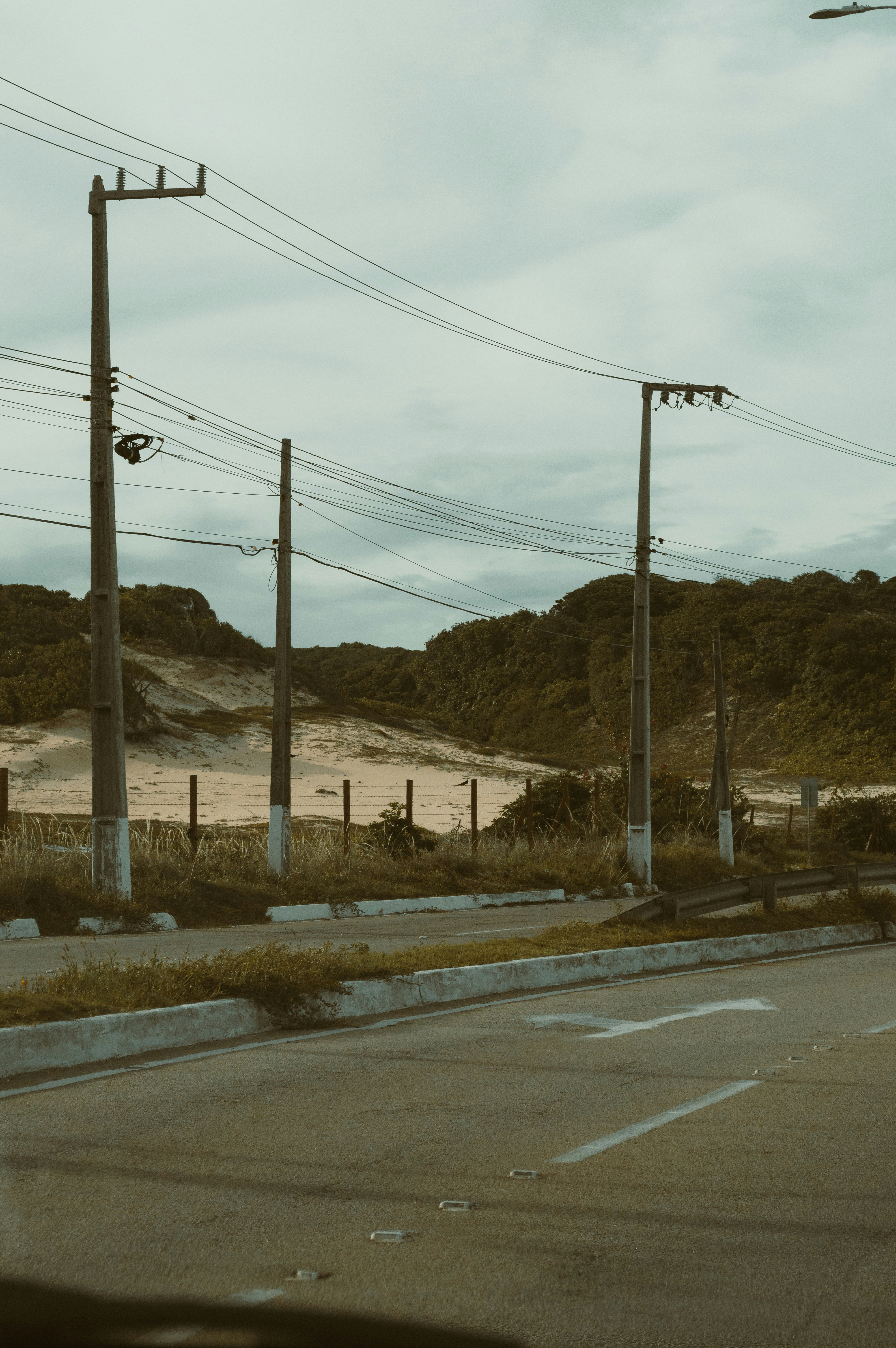 Dusty Coastal Road with Weathered Utility Poles