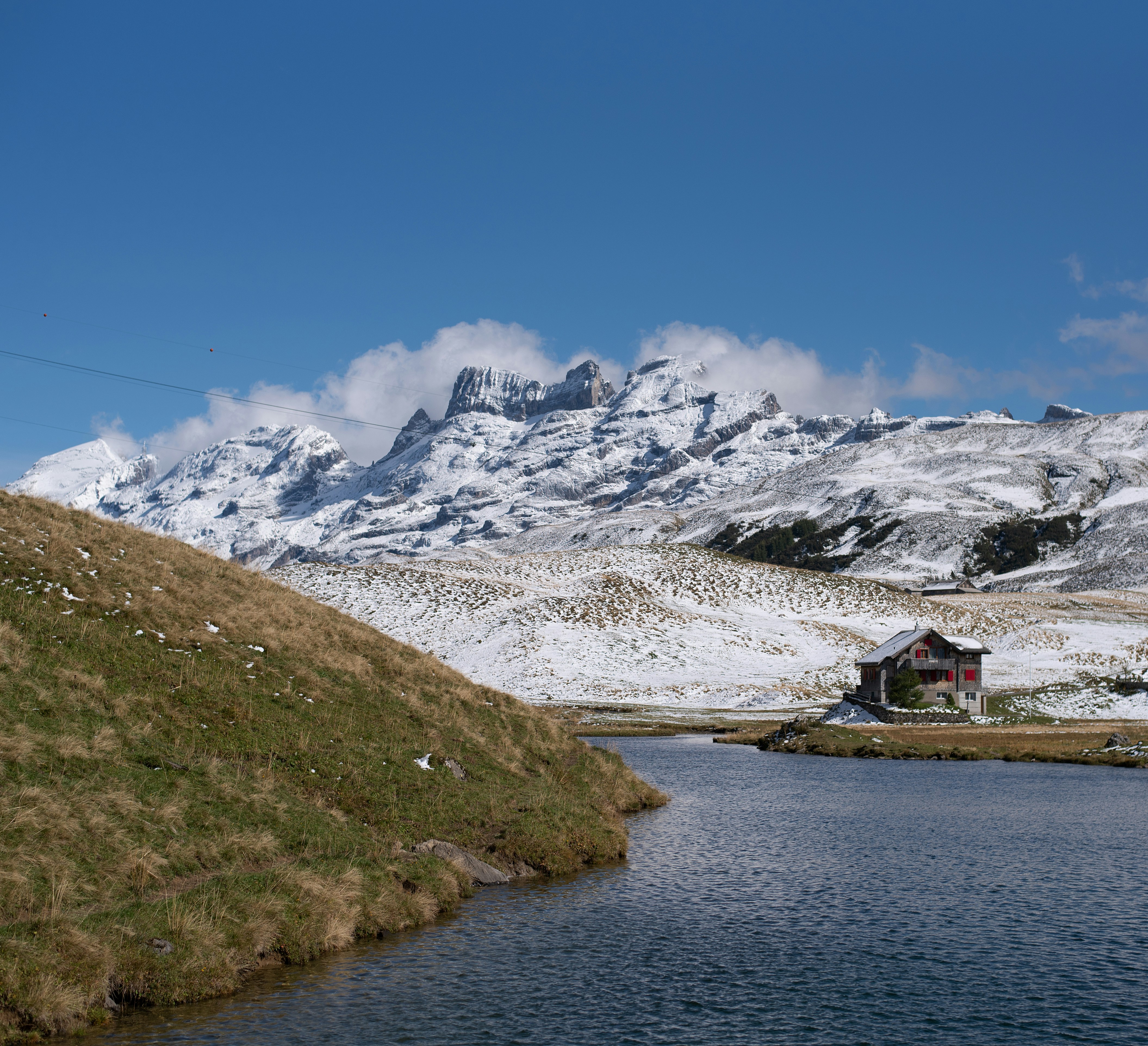 Snow-capped Ridge and tranquil lakeside cabin