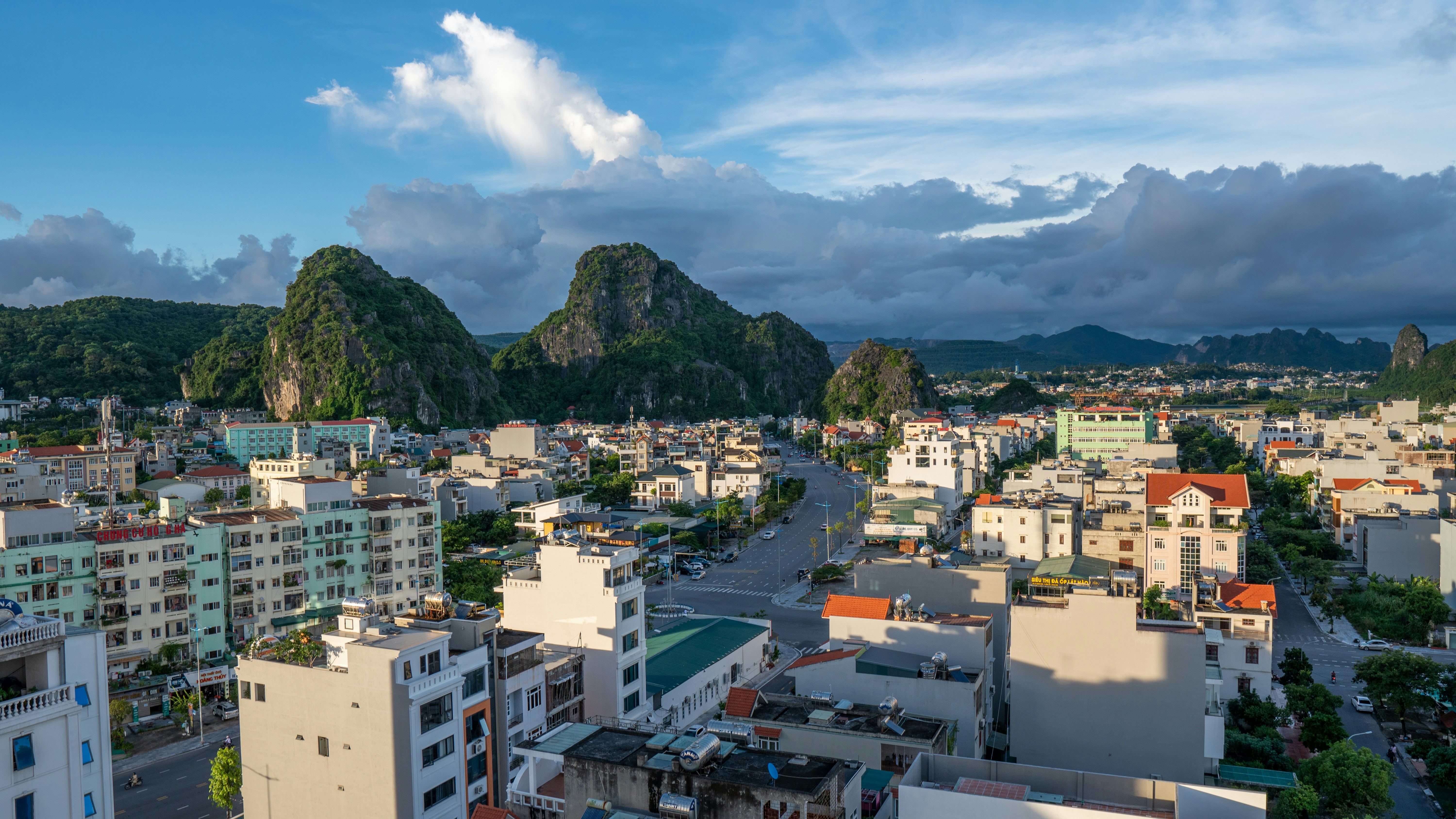 Sunlit Valleys and Cliffbound Peaks over a Vietnamese Coastal Town