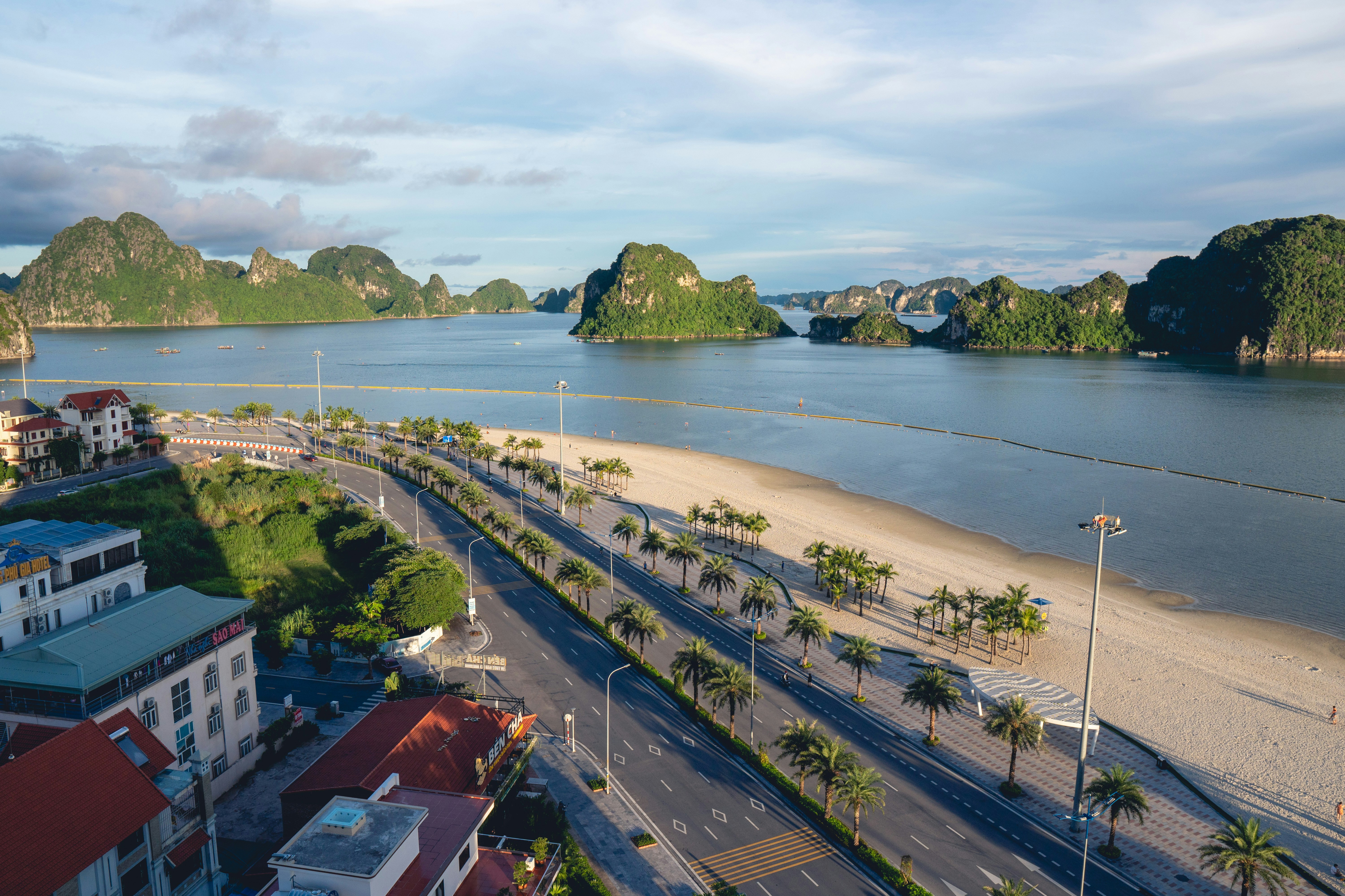 Palm-lined Boulevard Beside a Serene Bay and Limestone Islands