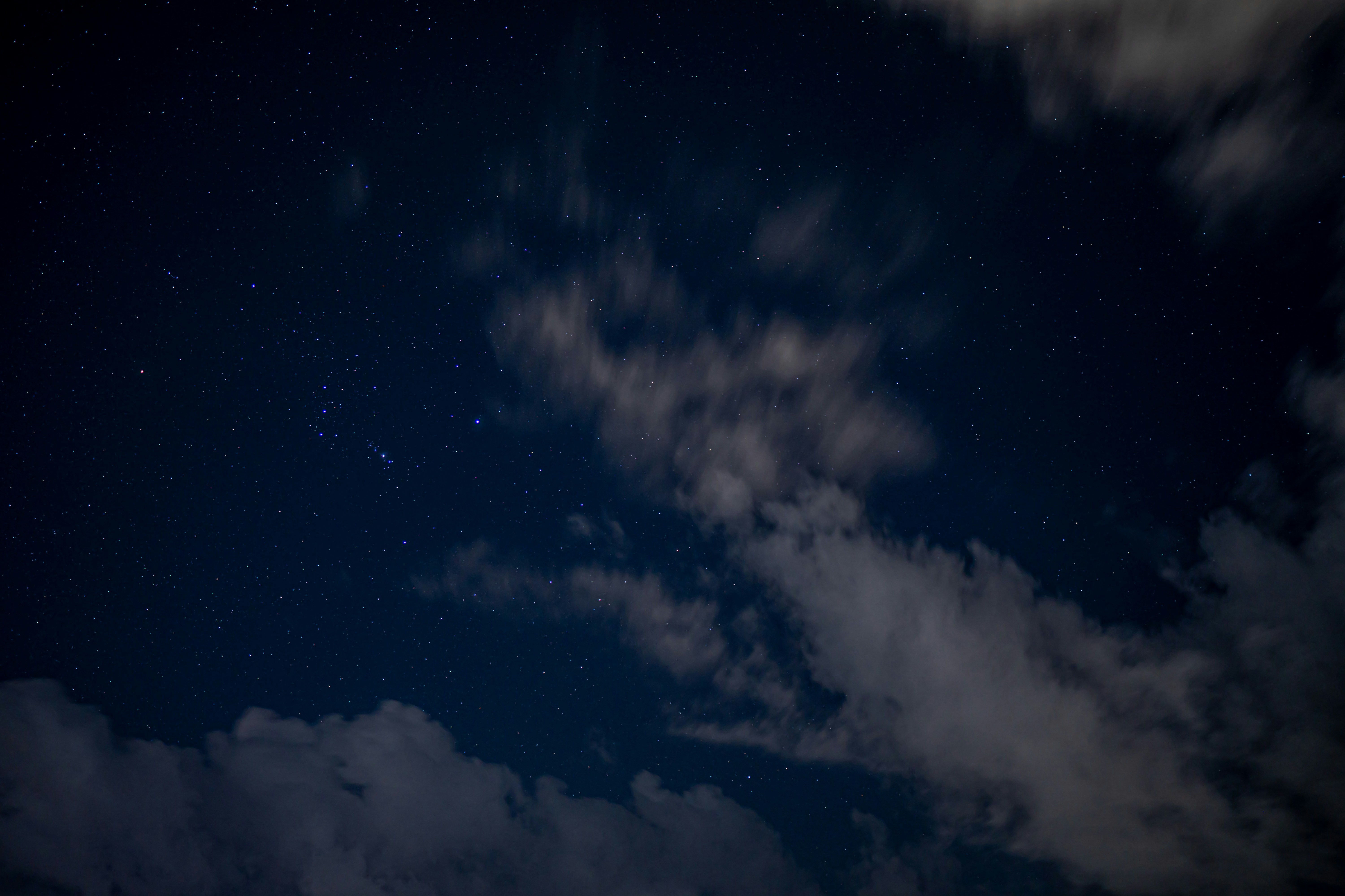 Stellar Veil: Stars Scattered Over a Moonlit Cloudscape