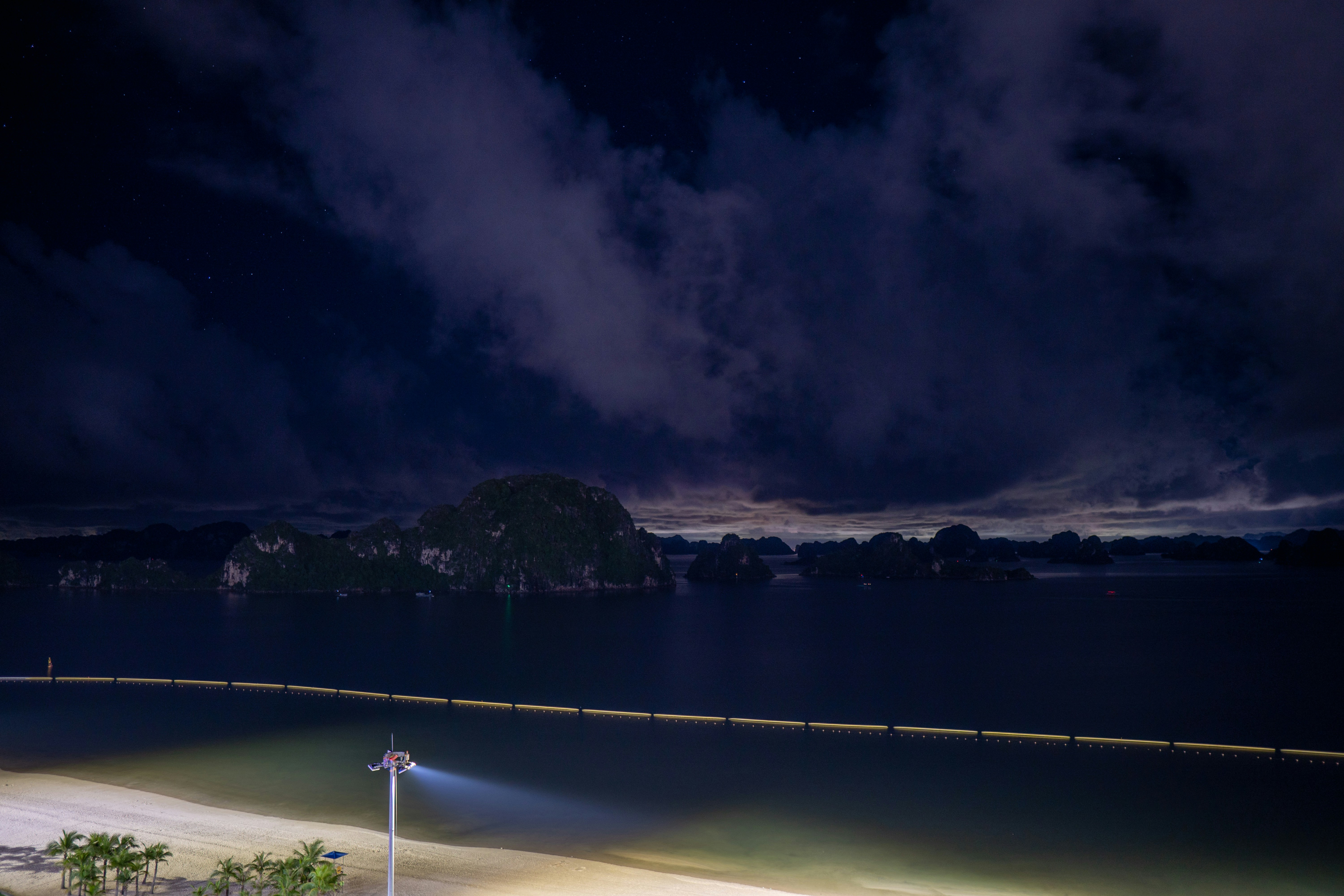 Moonlit Seascape Beneath a Cloud-Wrapped Night Sky