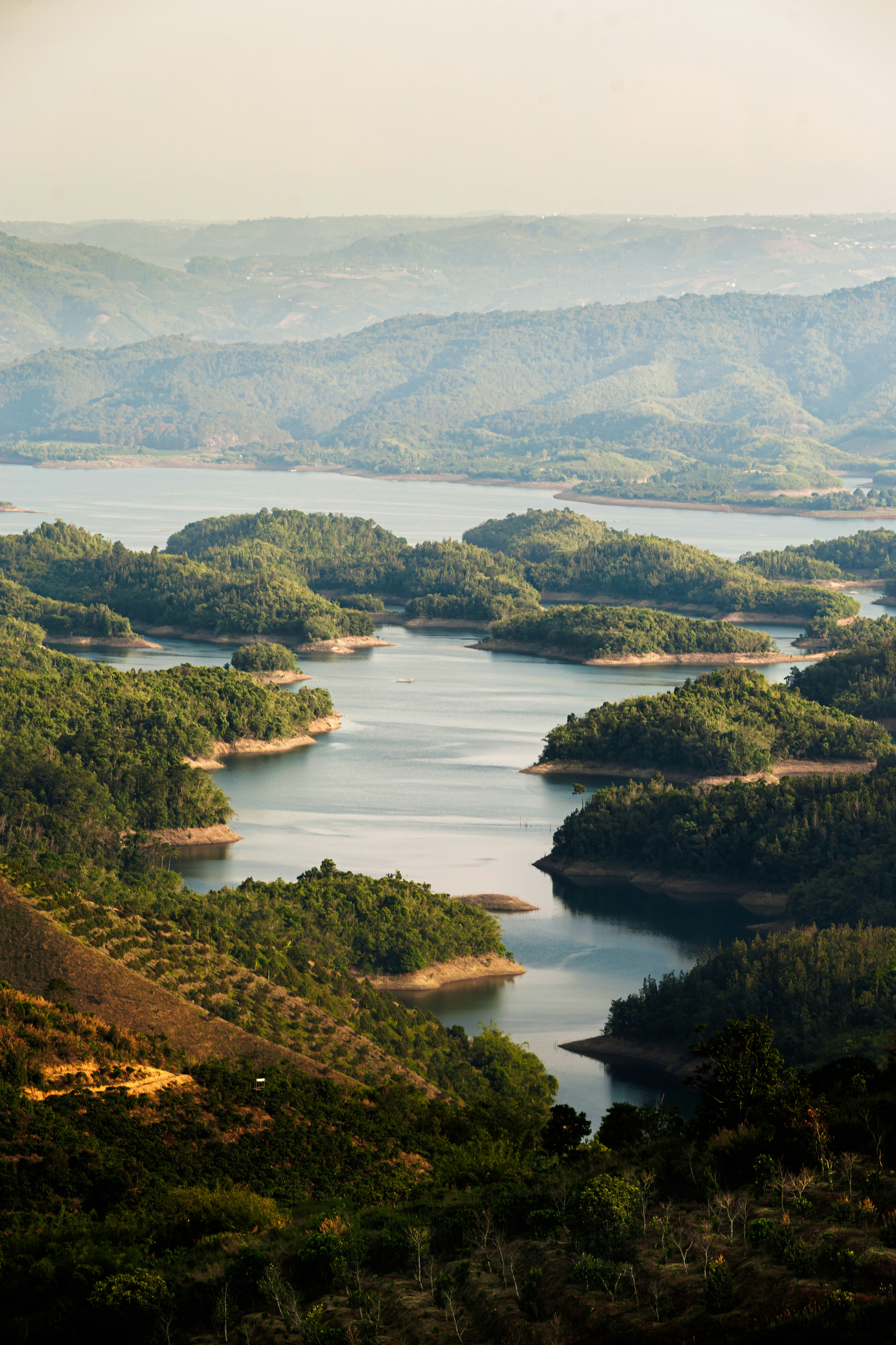 Islands of Light: A Serene Dammed Channel Woven Through Hills