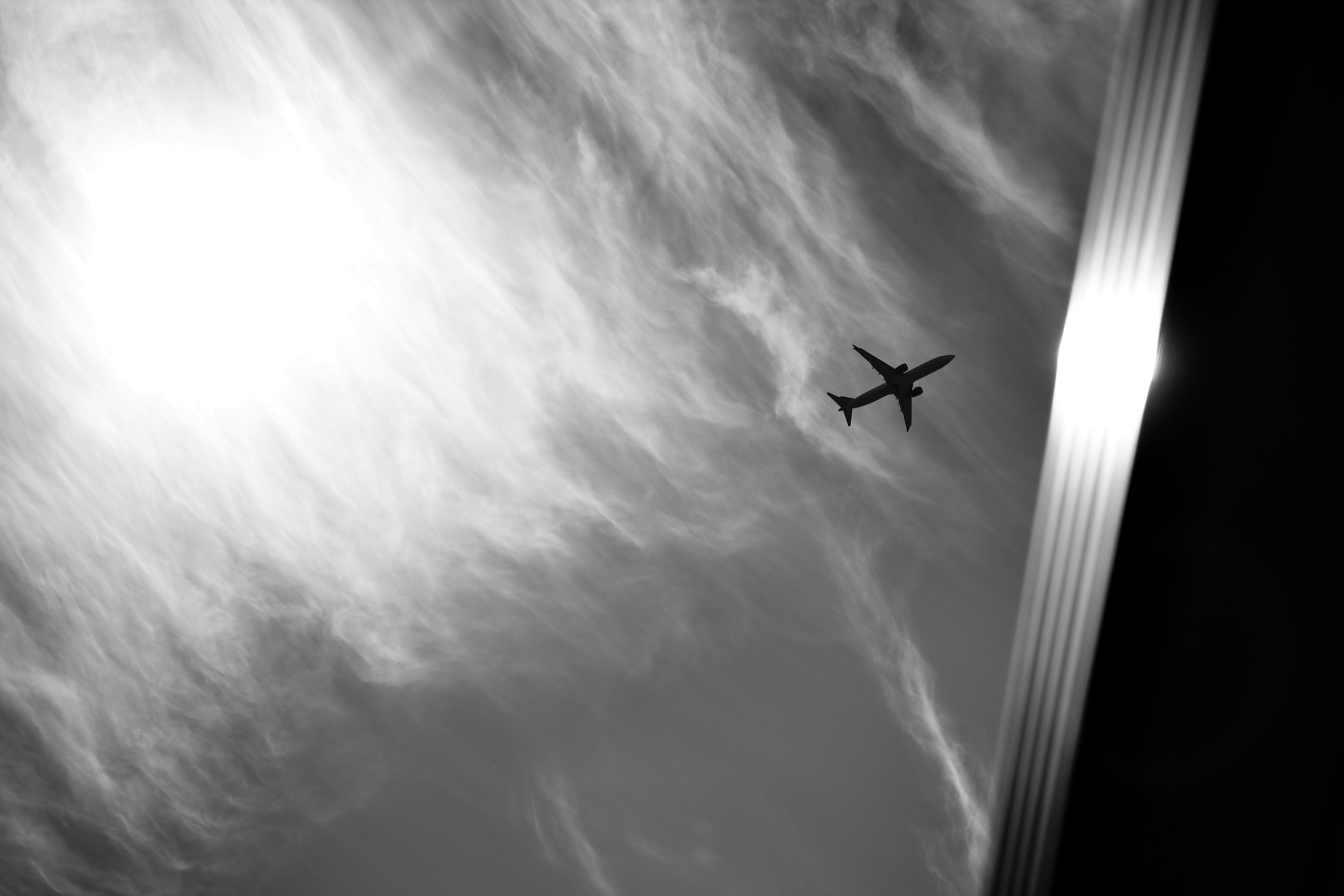 Contrail Skies: An Airplane Crossing the Sunlit Veil