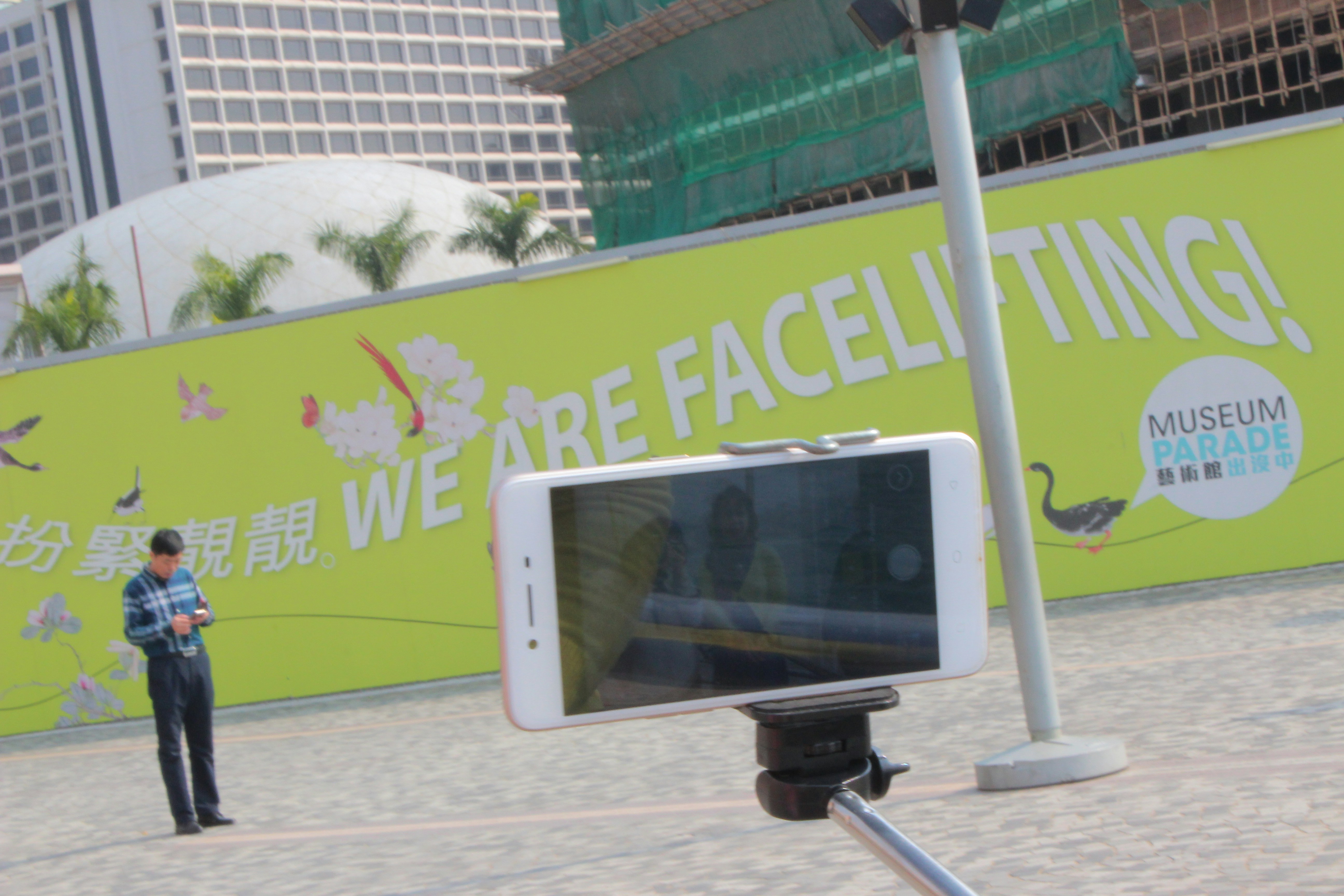 Smartphone on a Monopod in a Bright City Square