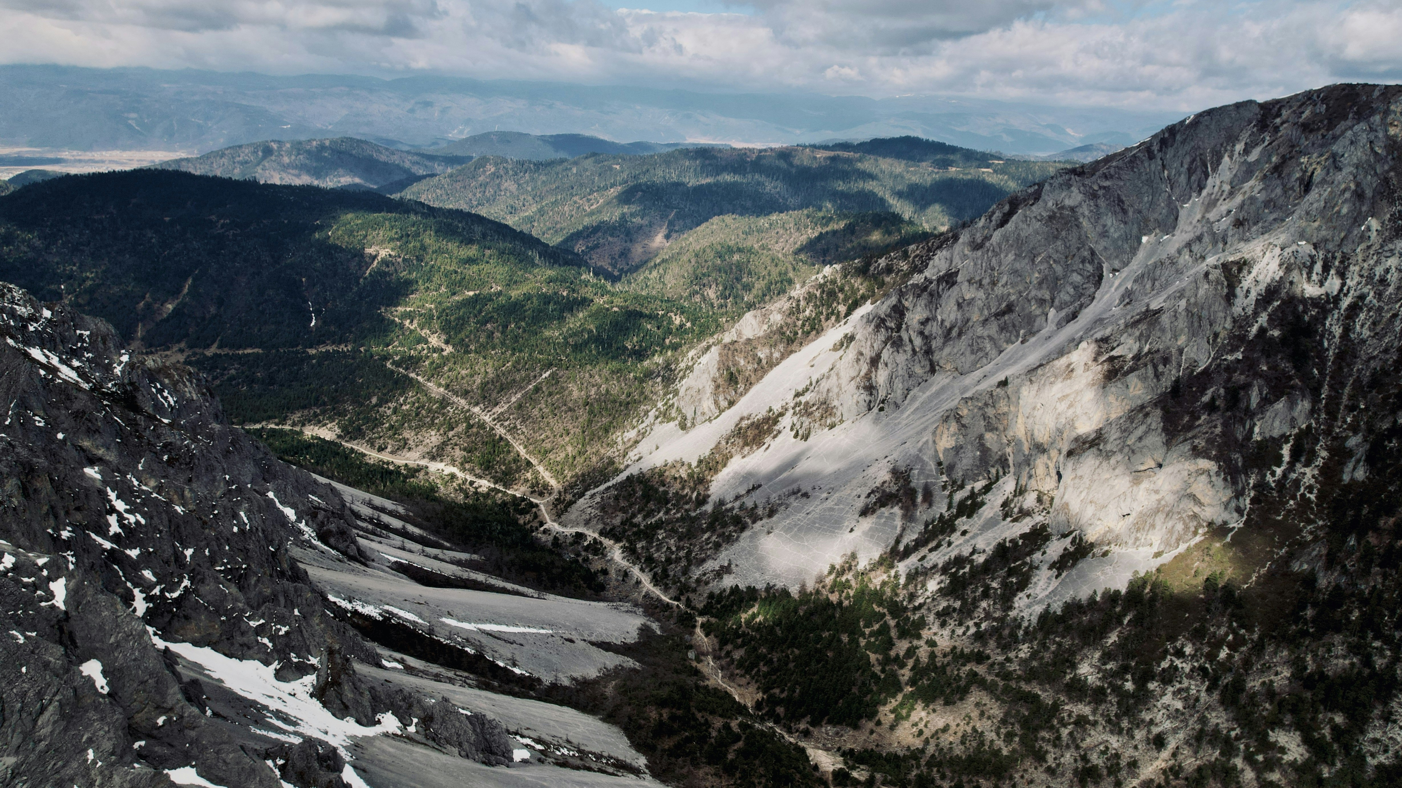 Snow-dusted Rim Overlooking a Valley of Pine and Rock