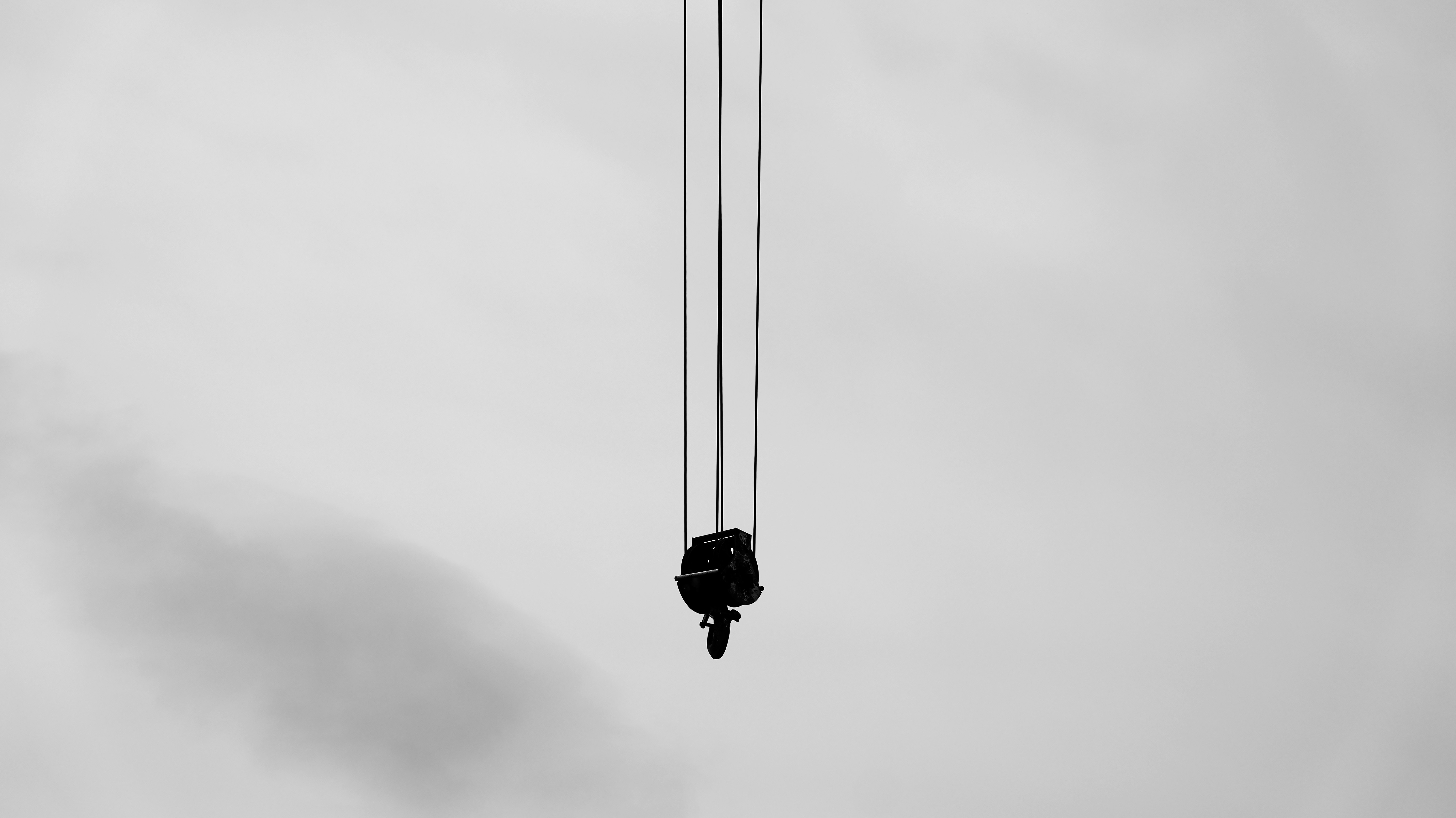 Suspended Silhouette: A Lone Climber Drifts Against the Sky