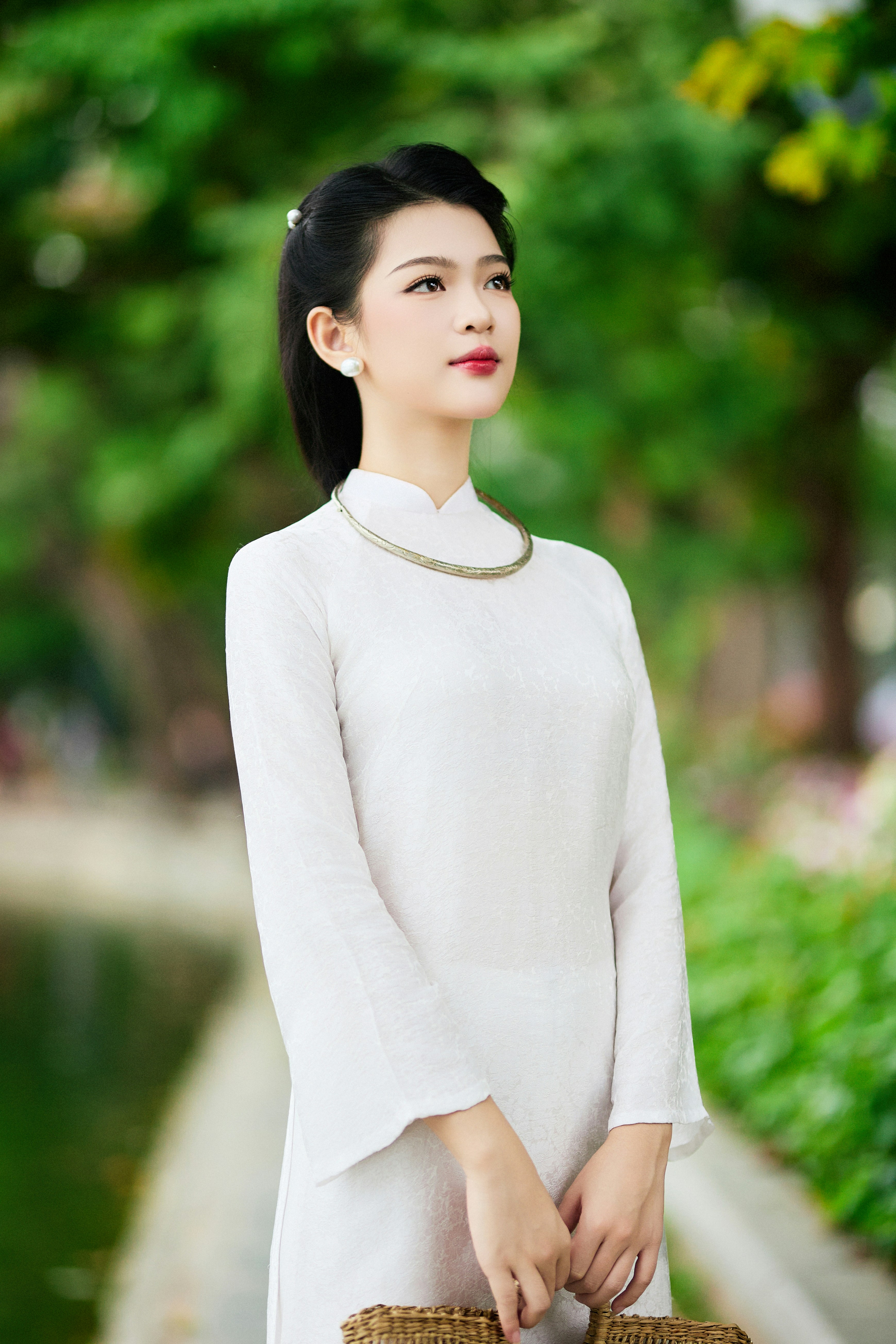Graceful Poise in White: Serenity Among Greens