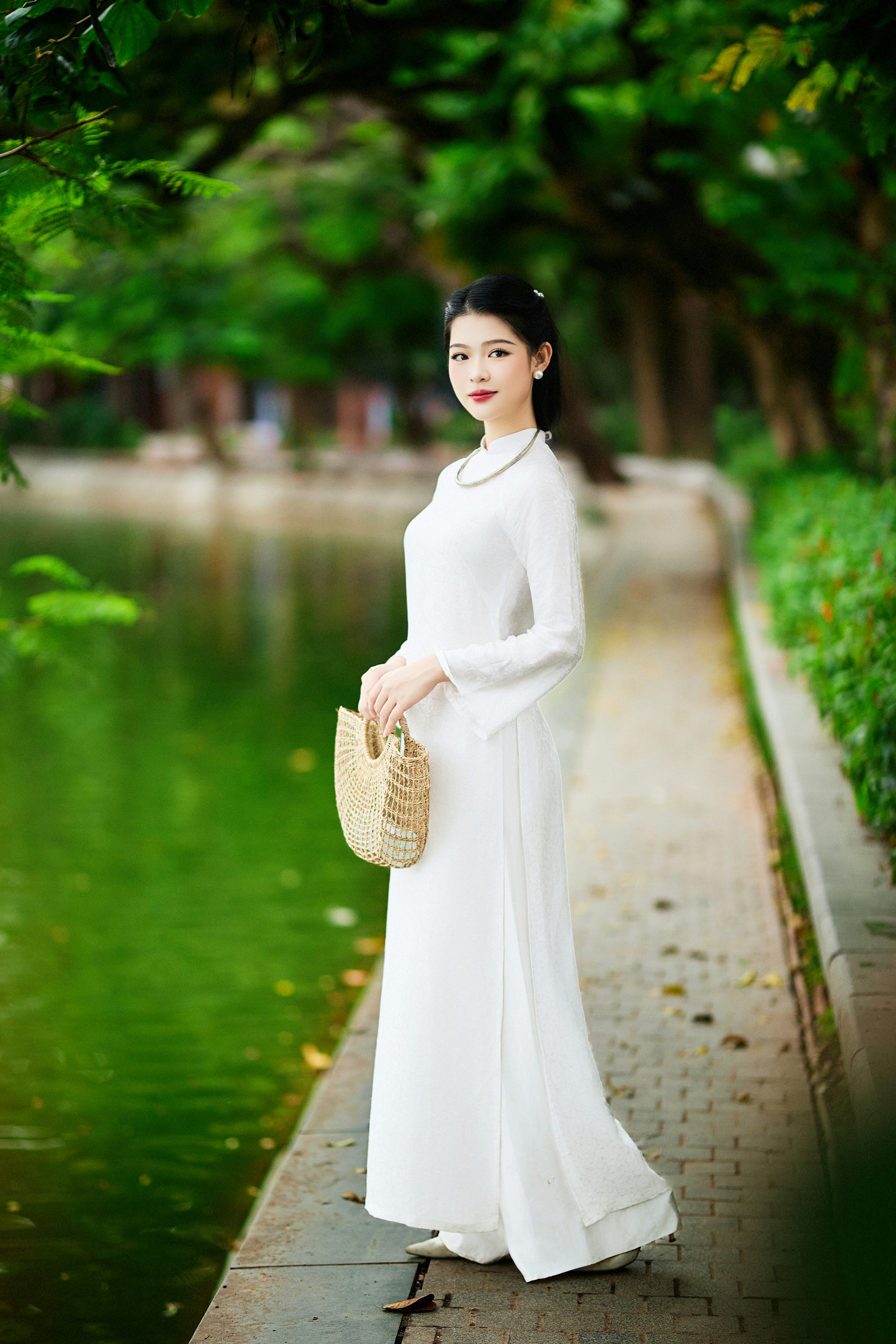 Poised in White: Serenity Along the Riverside Walk
