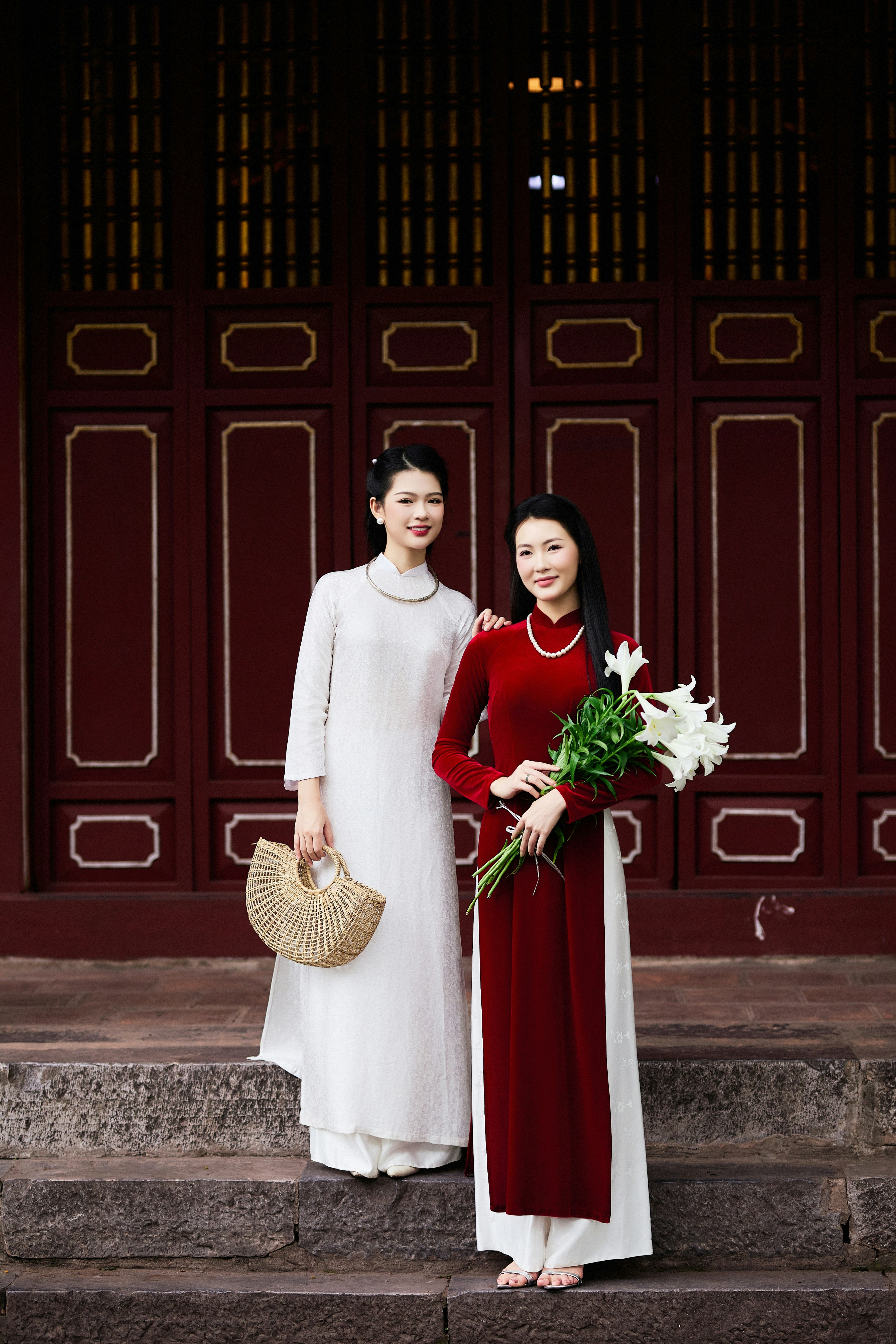 Two Women in Qipao at a Red-Walled Courtyard