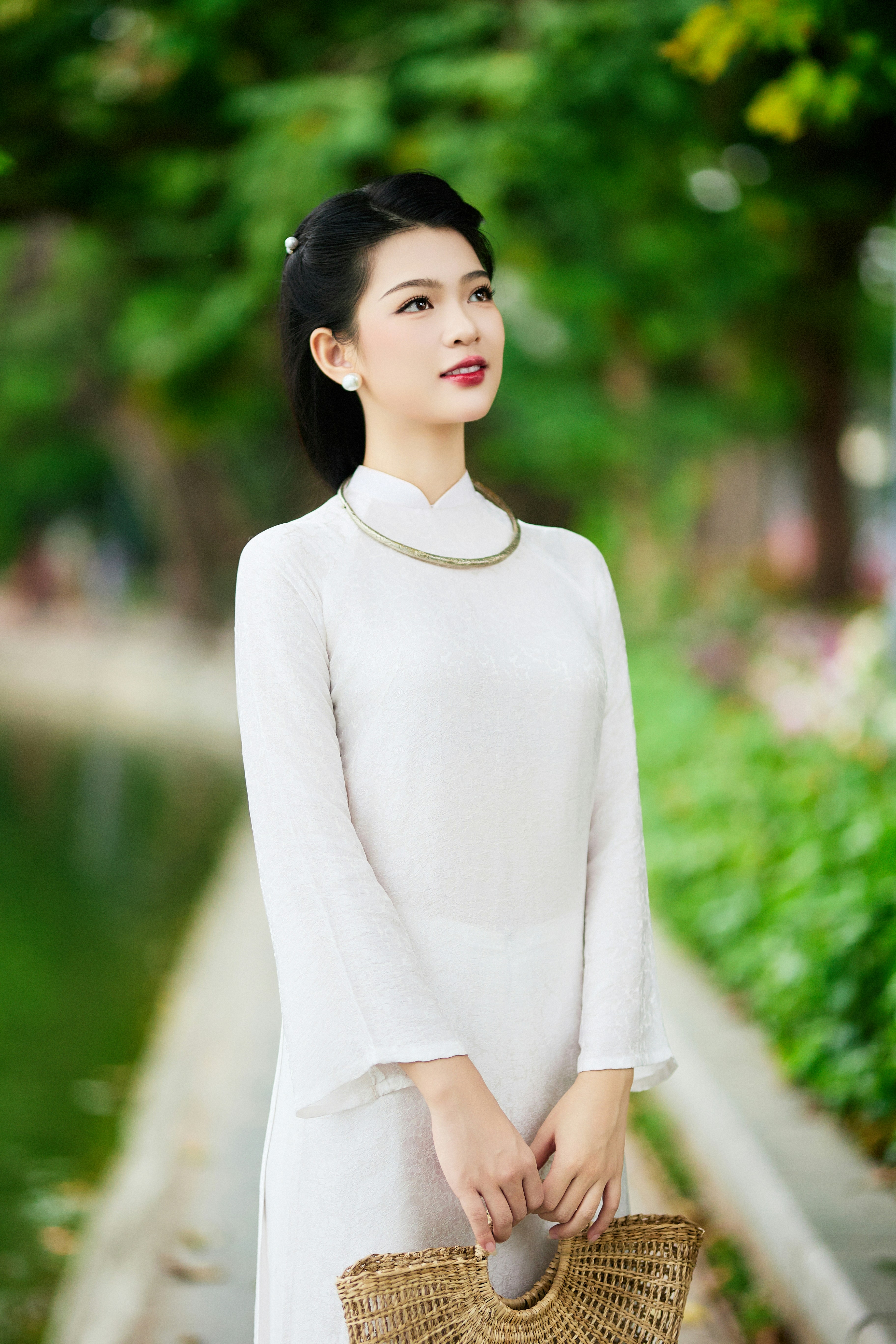 Grace in White: Portrait of Quiet Elegance by the Canal