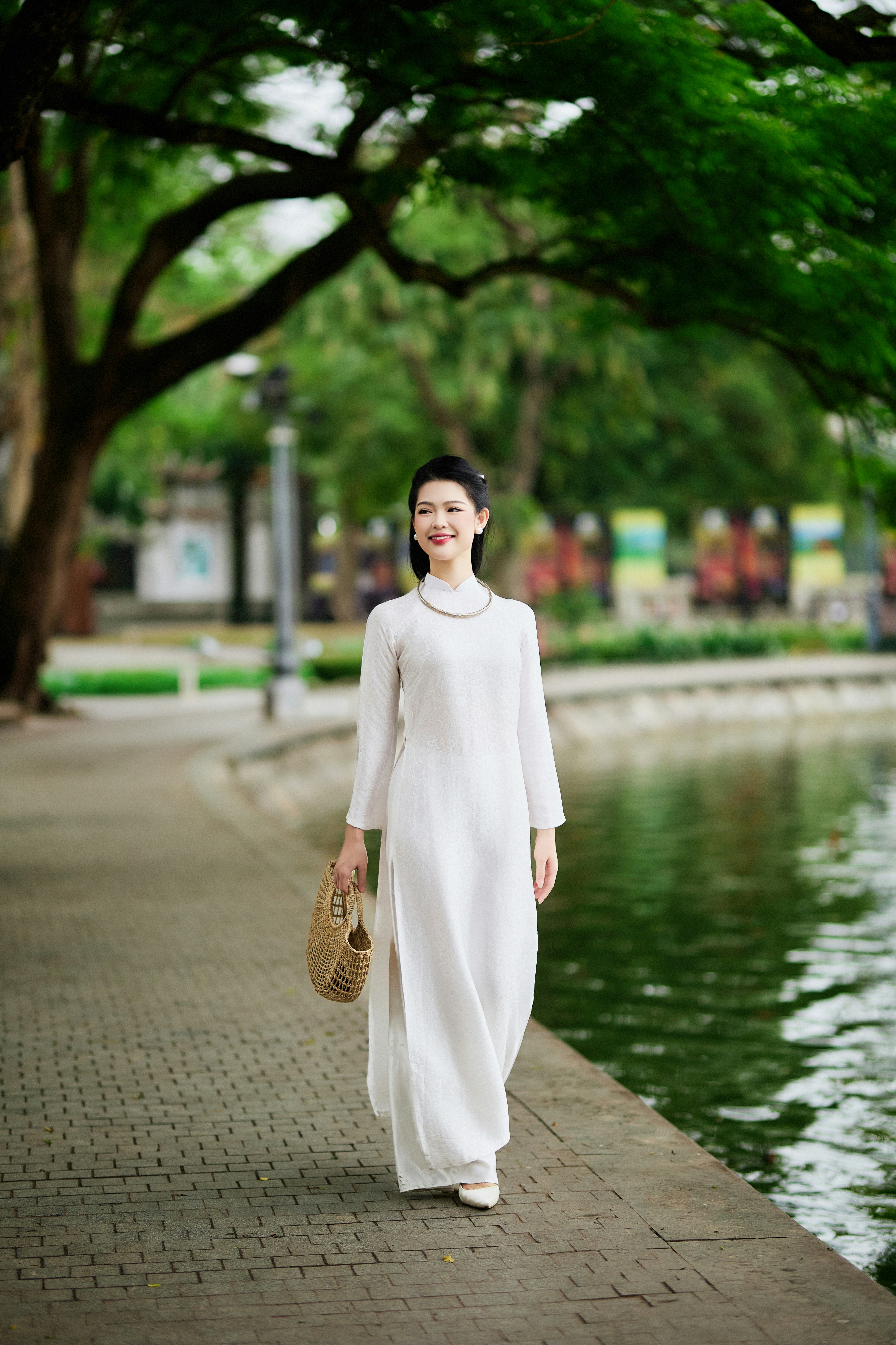 White-qipao stroll by the garden pond
