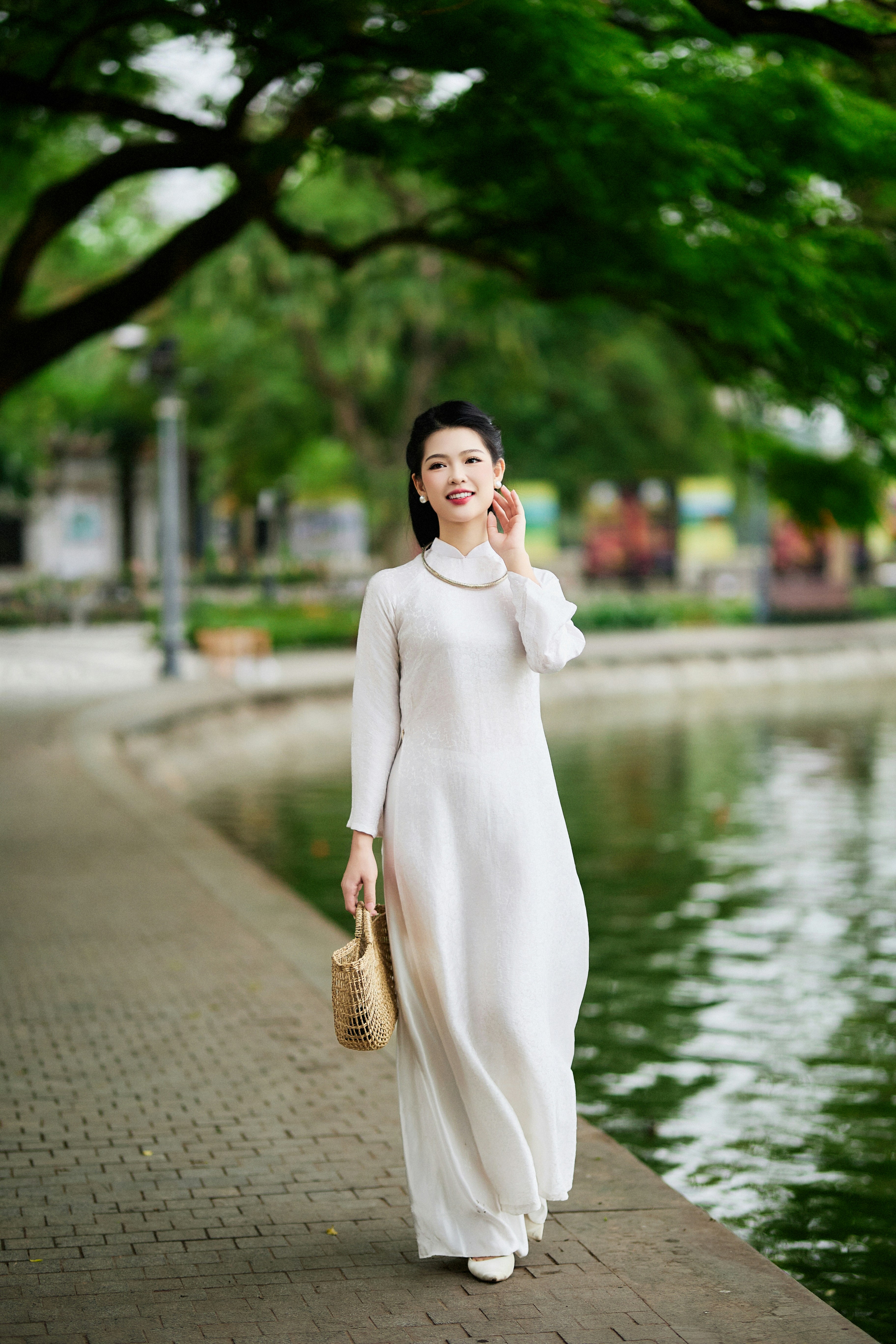 Elegance Along the Riverside: a Poised Portrait in White