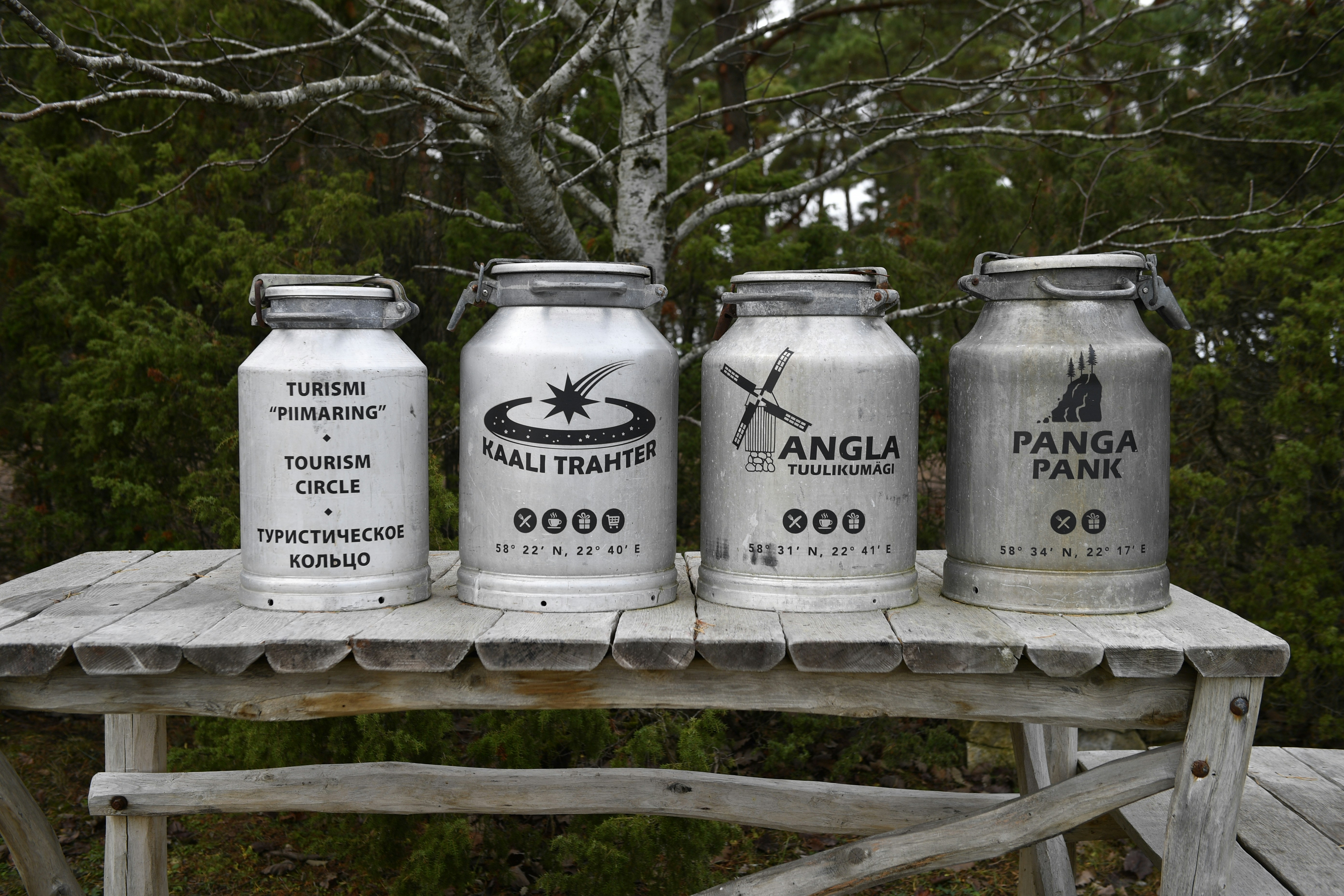Row of Weathered Milk Cans on a Rustic Wooden Platform