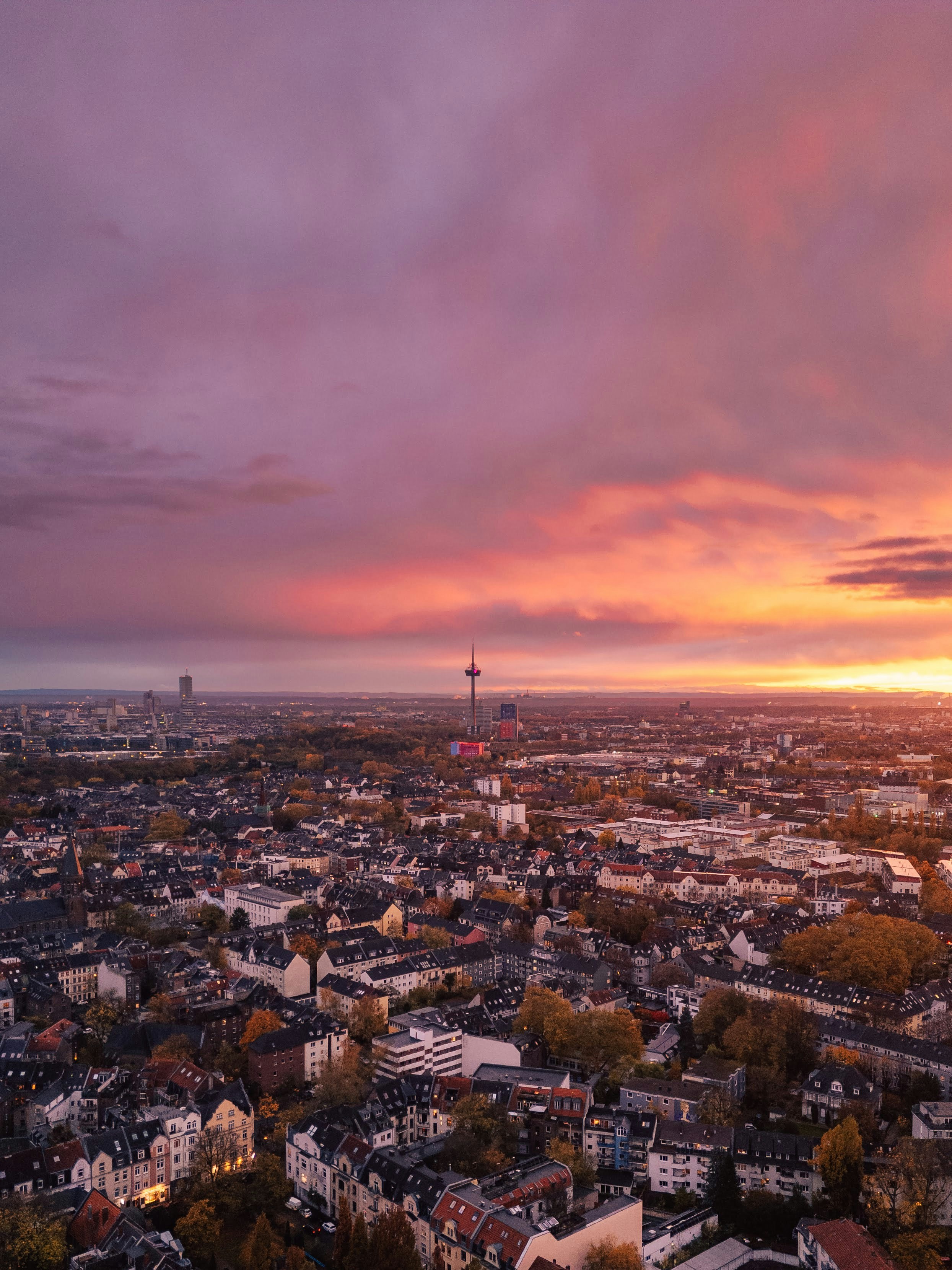 Sunset Over a Quiet City: Aerial Panorama of Rooftops and a Sky on Fire