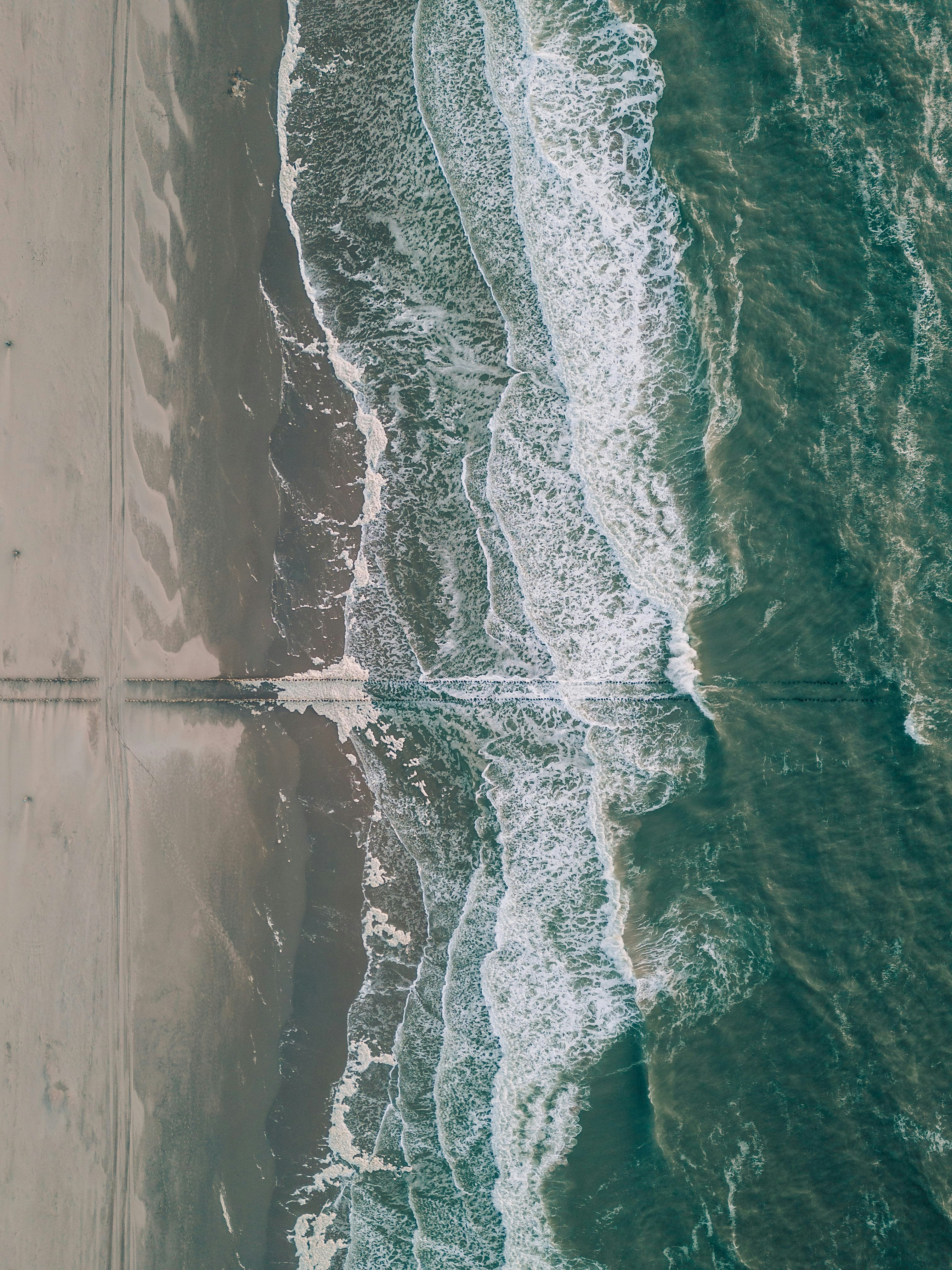Aerial Tide: Parallel Waves Meeting a Shoreline Ribbon