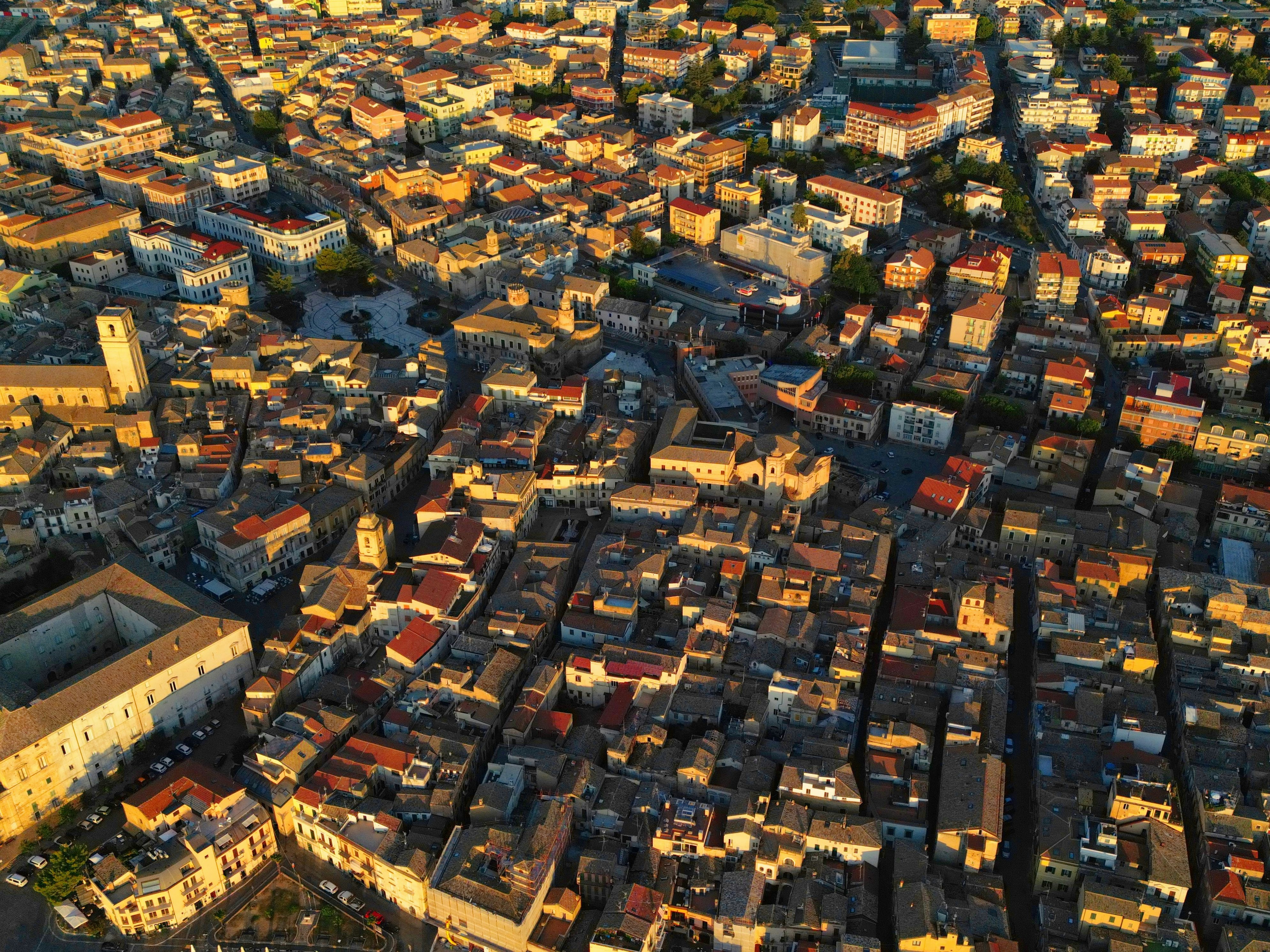 Sunlit City Blocks: A Quiet Aerial Tapestry of Rooftops