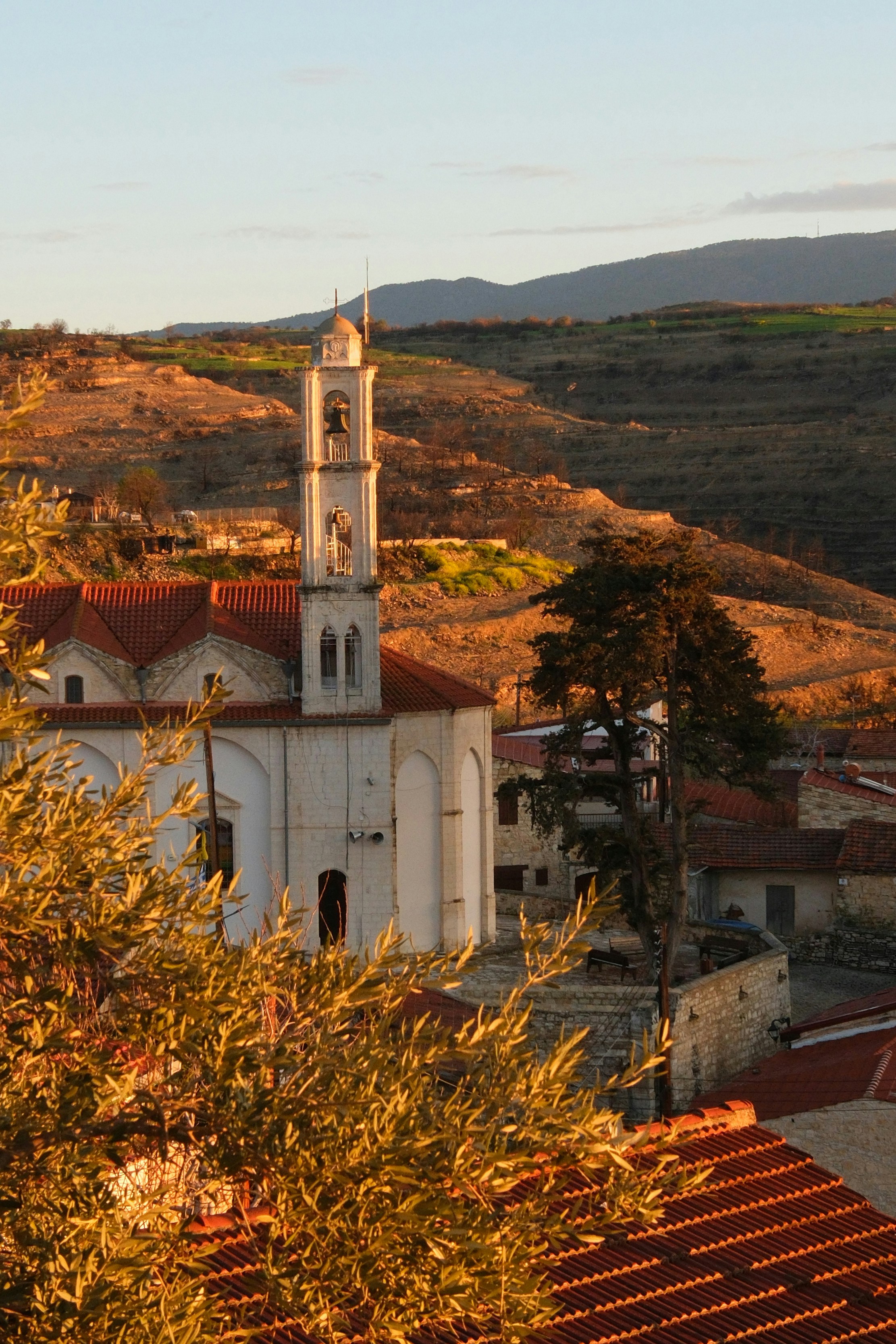 Bell Tower in Golden Hour Overlooking Rustic Hills