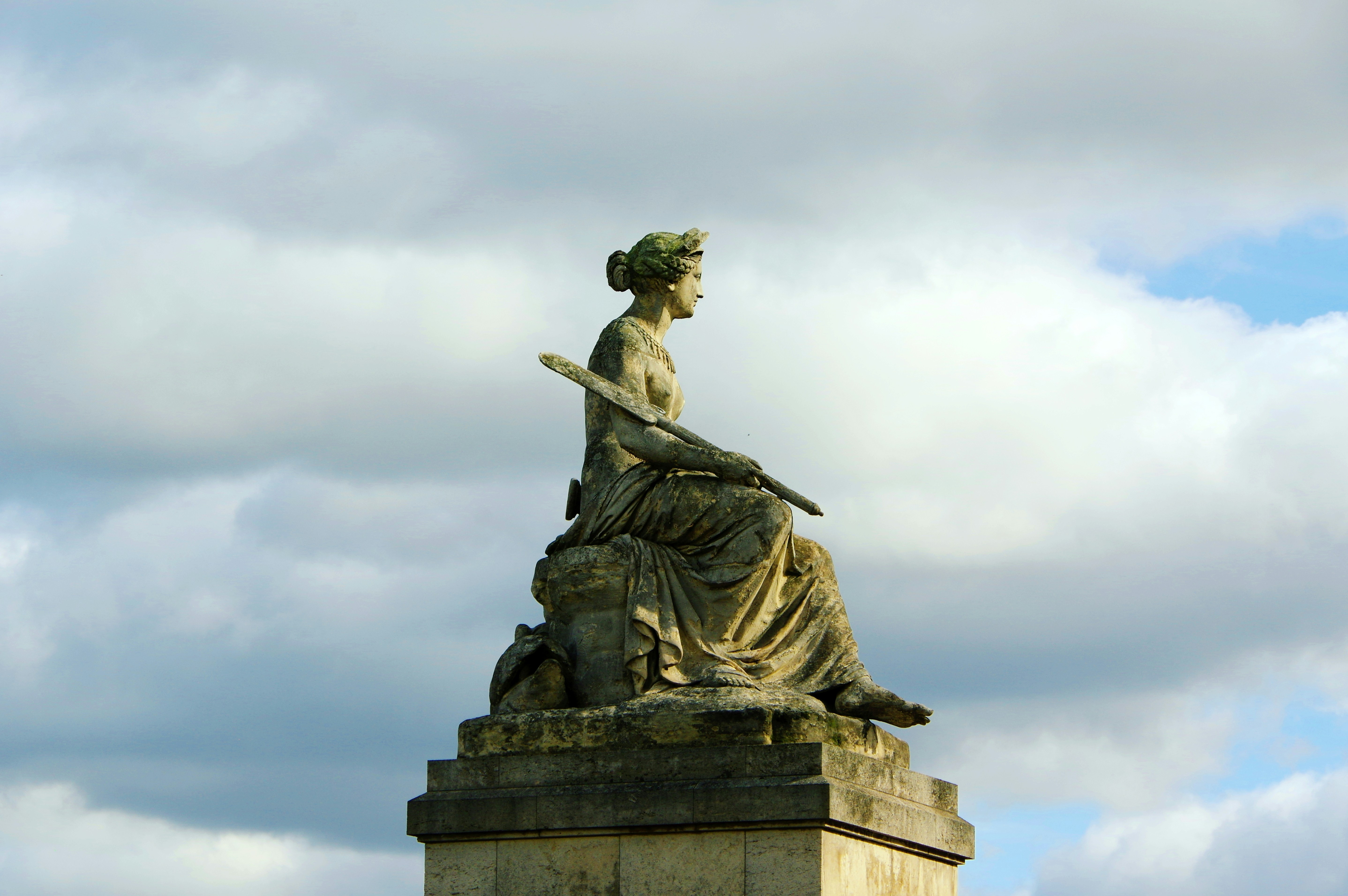 Stone Sentinel: A Seated Goddess Guarded by the Sky