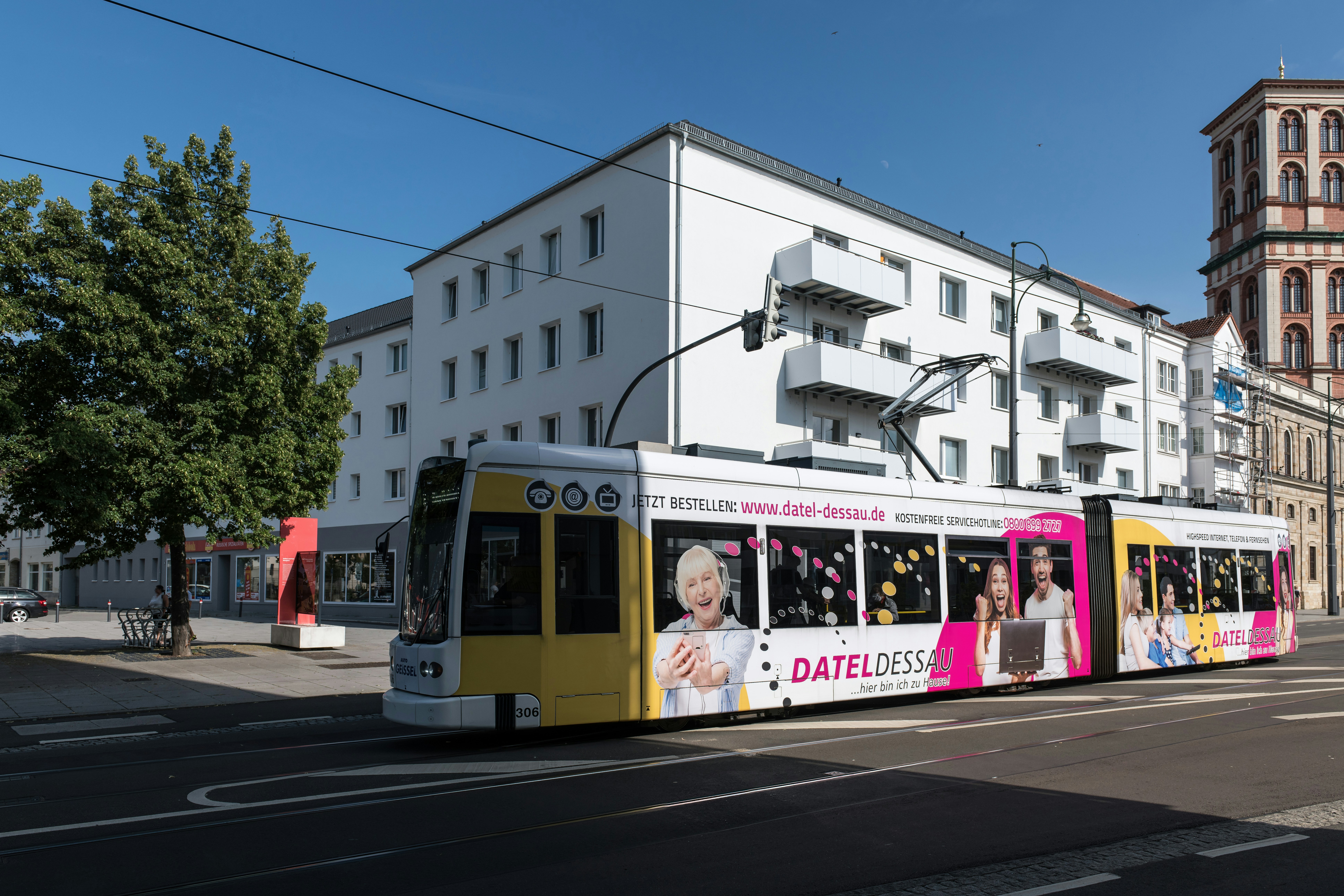 Sunlit tram Adrift Through a Modern European Street