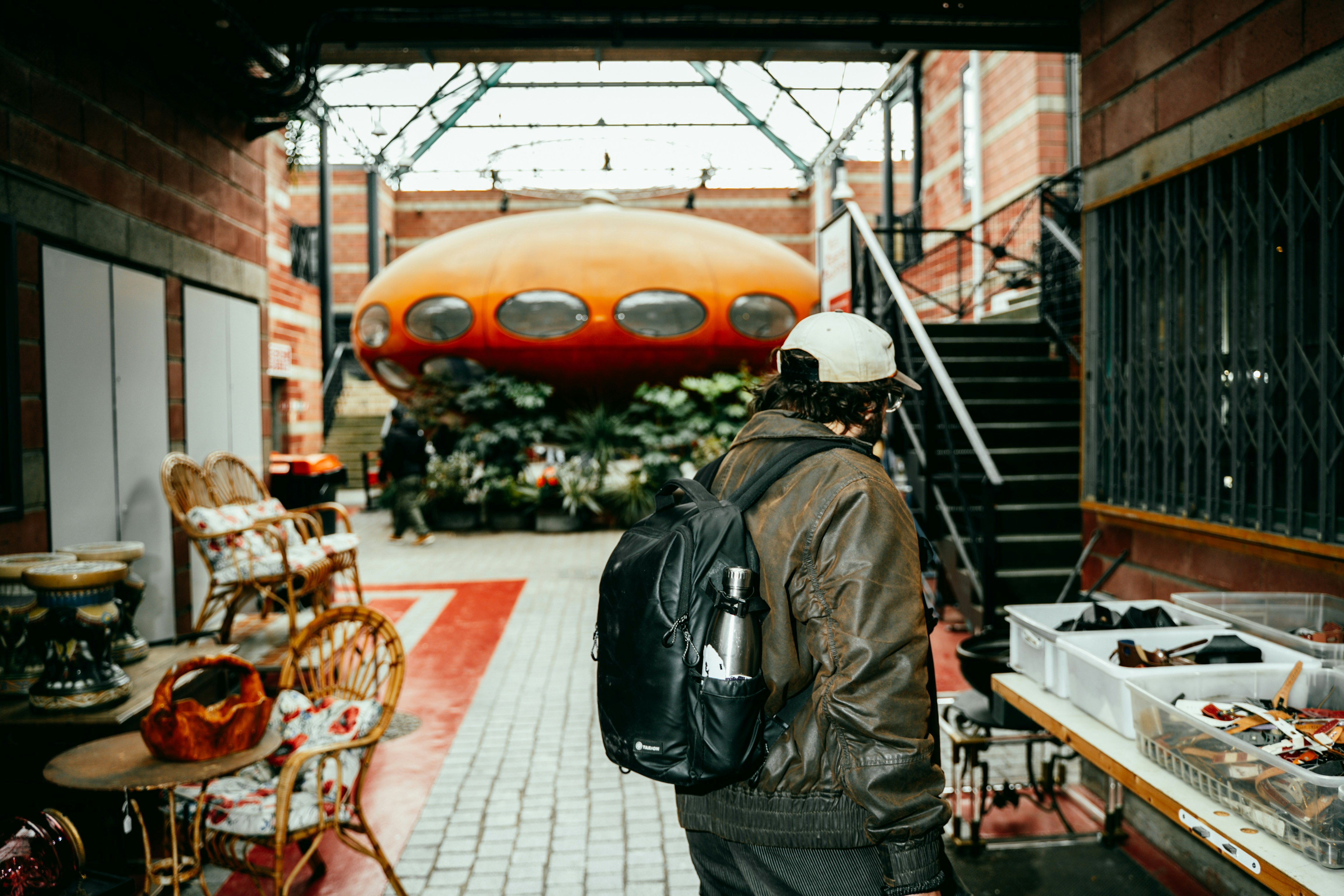 Backwalk to the Orb: A Portrait of Curiosity in an Industrial Hall