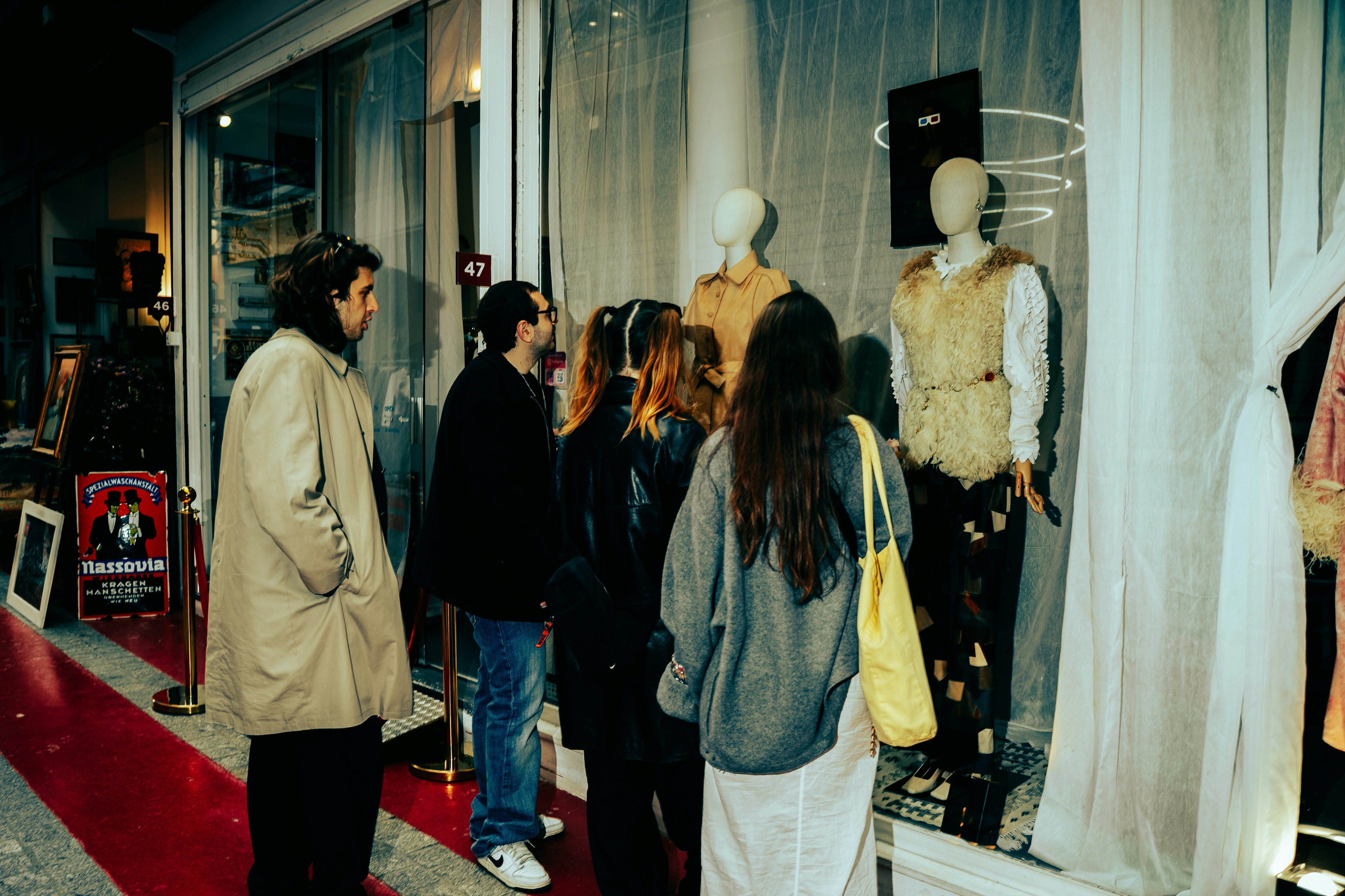 City Boutique Window: Crowd of Shoppers Gazing at Mannequins