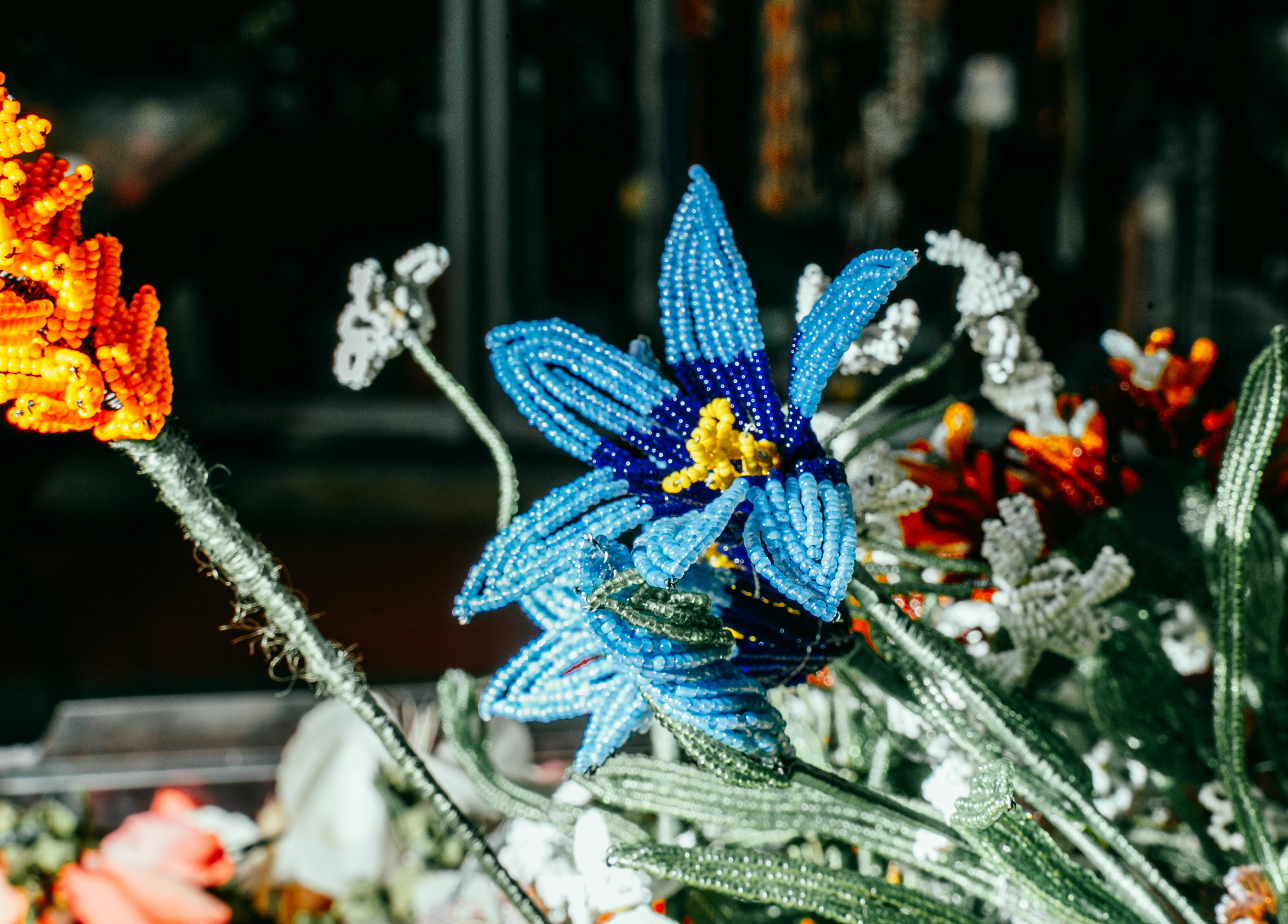 Bejeweled Bloom: A Blue Flower Surrounded by Fringed Florals