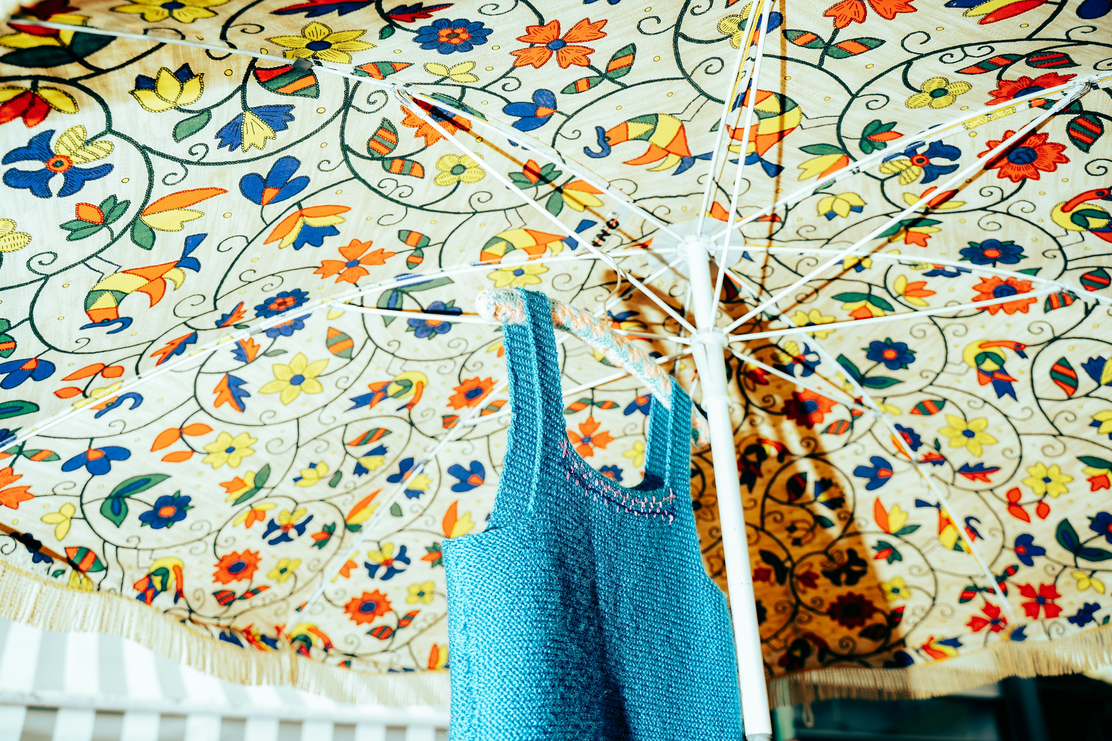 Blue Garment on a Floral Outdoor Umbrella Frame