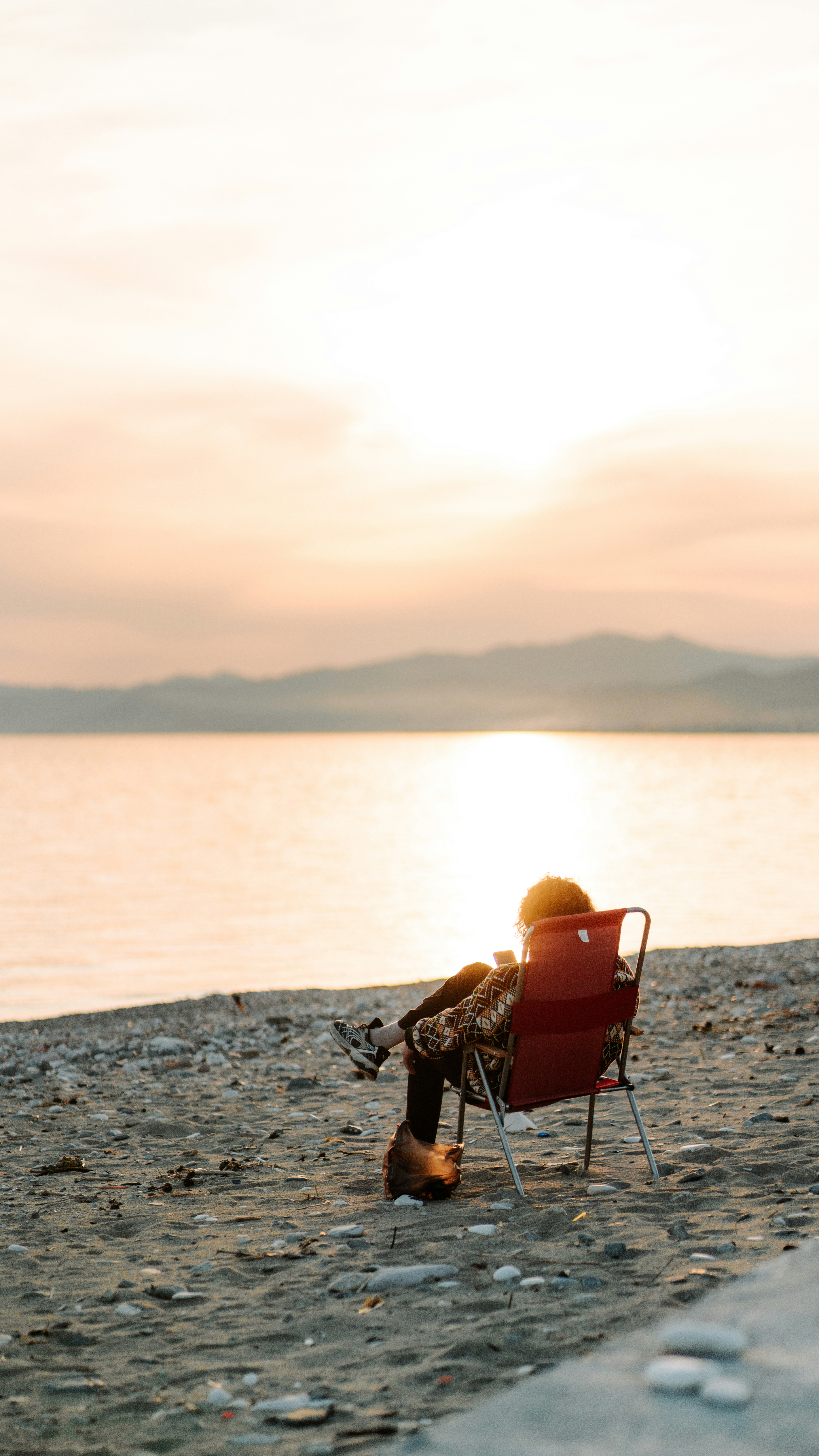 Sunset Refuge: A Reclining Figure by the Quiet Shore