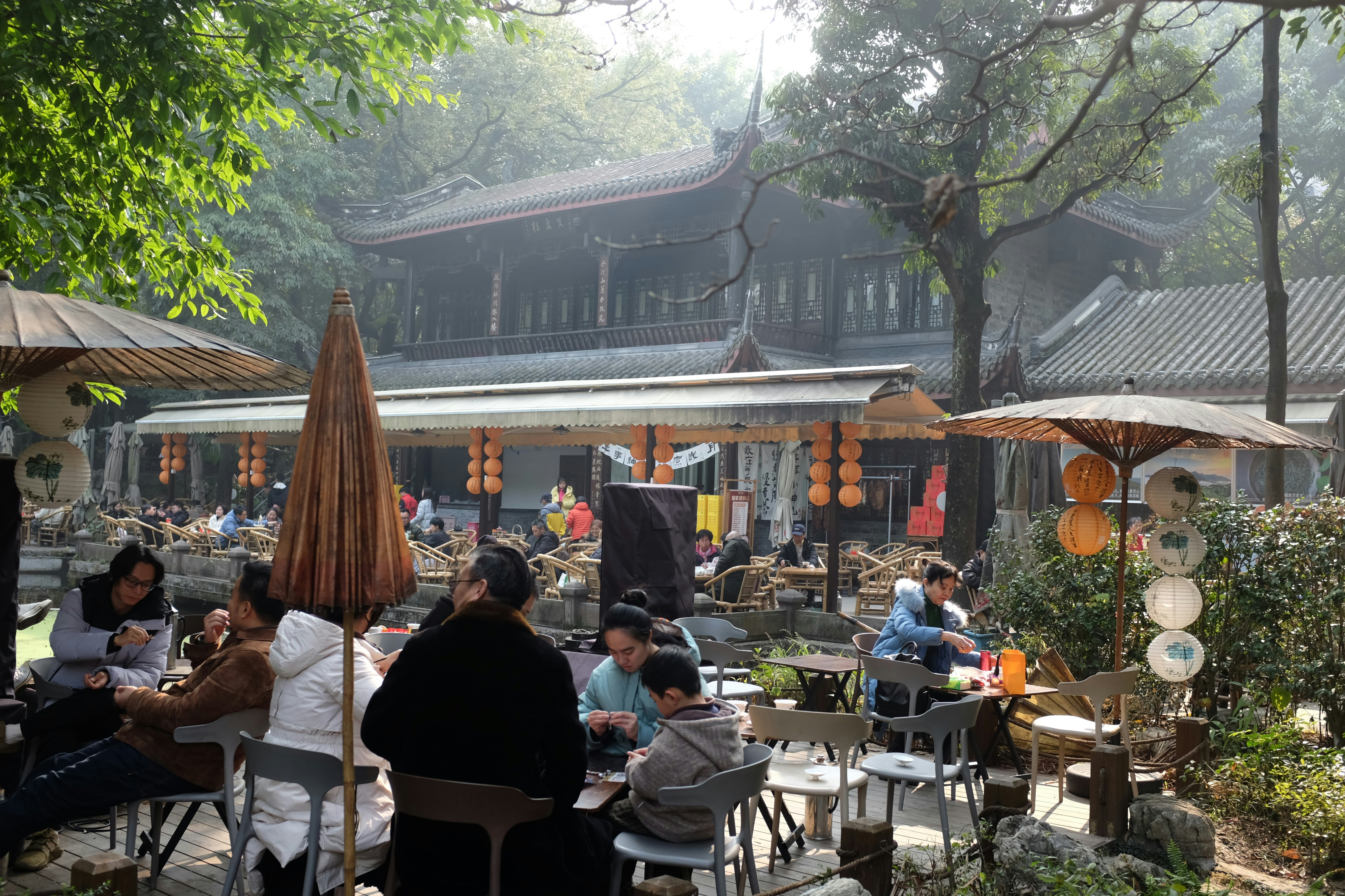City Courtyard Café Under Lanterns and Shaded Trees