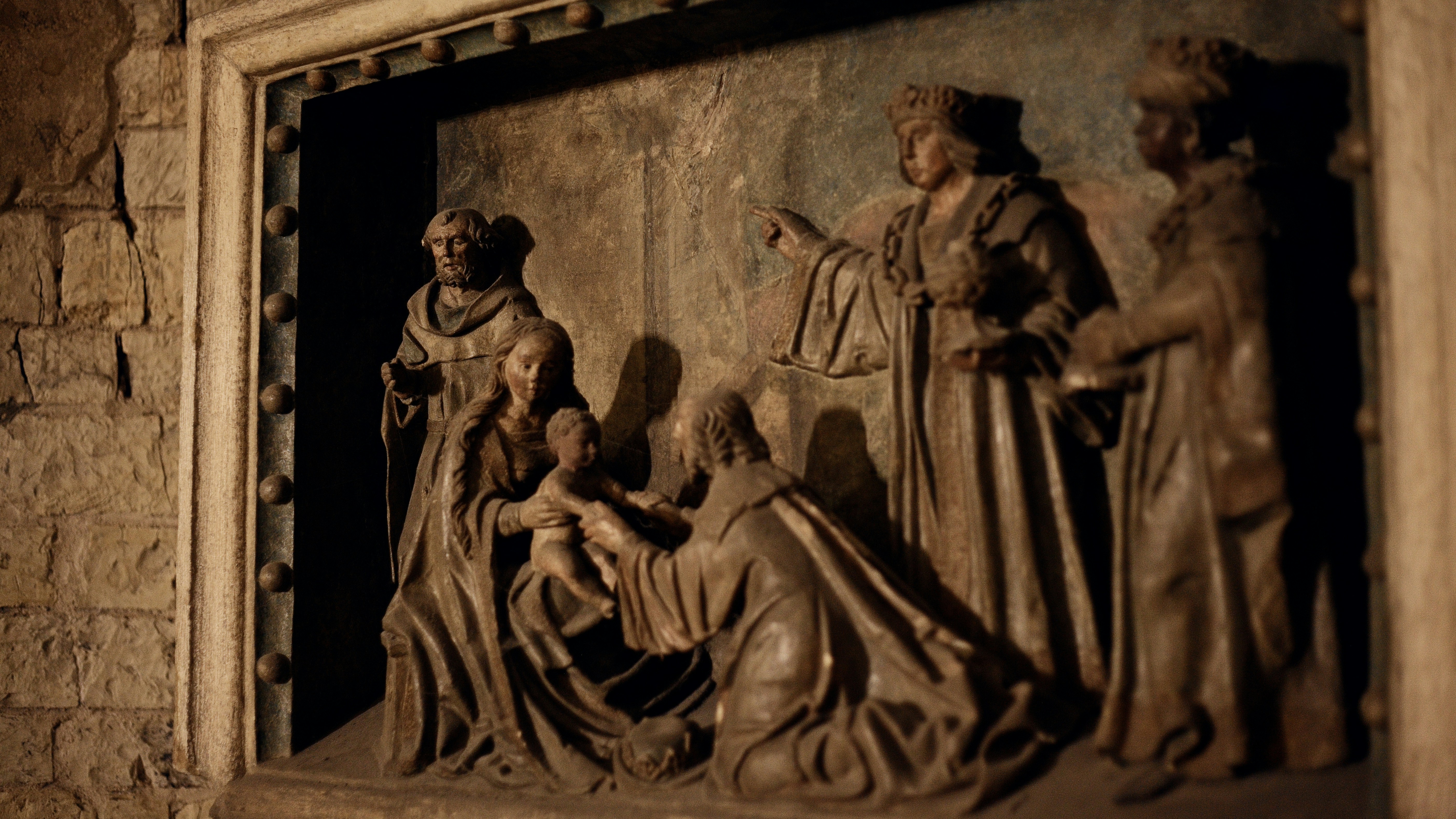 Relief of Grace: sculpted figures gathered around a central act
