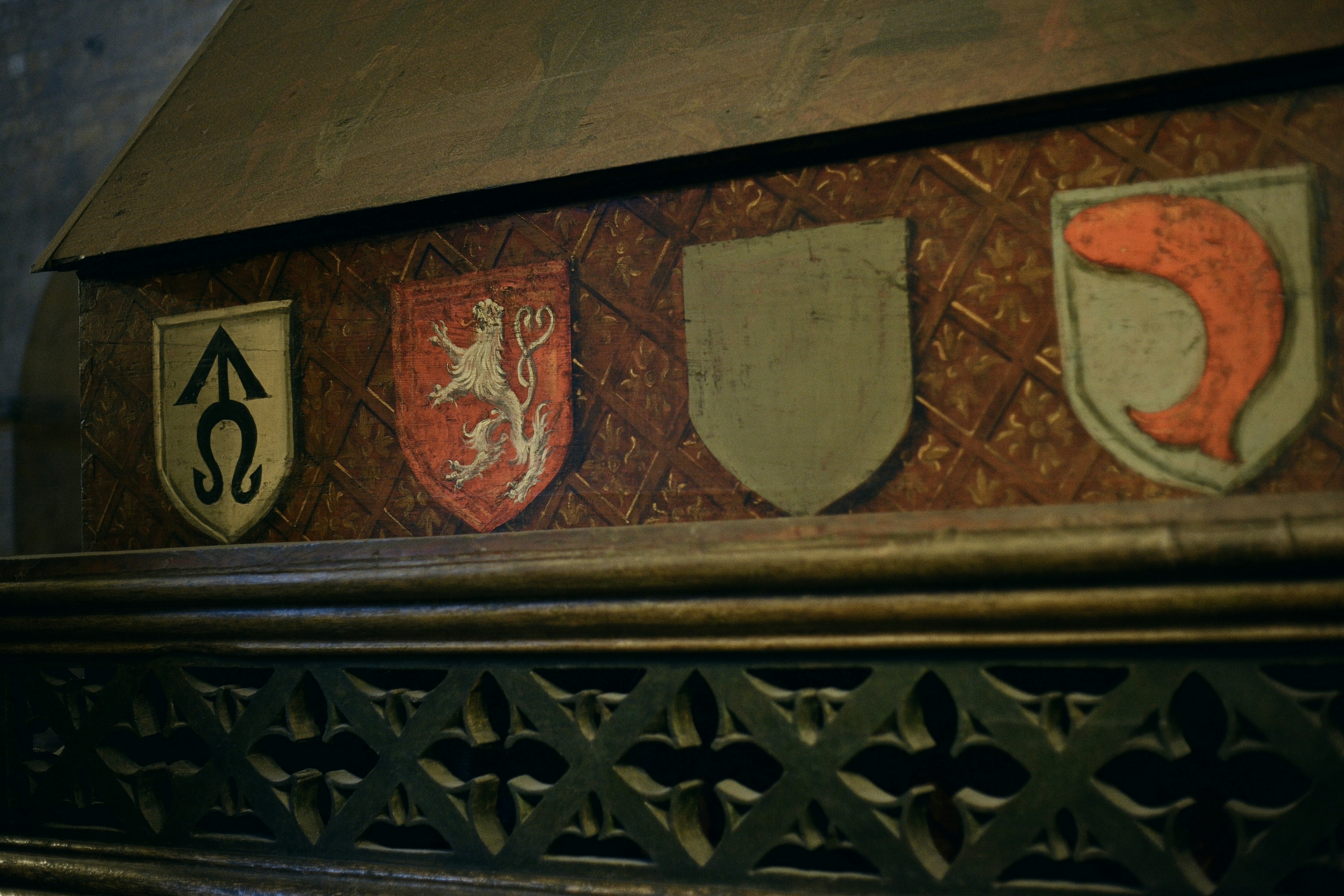 Heraldic Shields Across Dented Wood