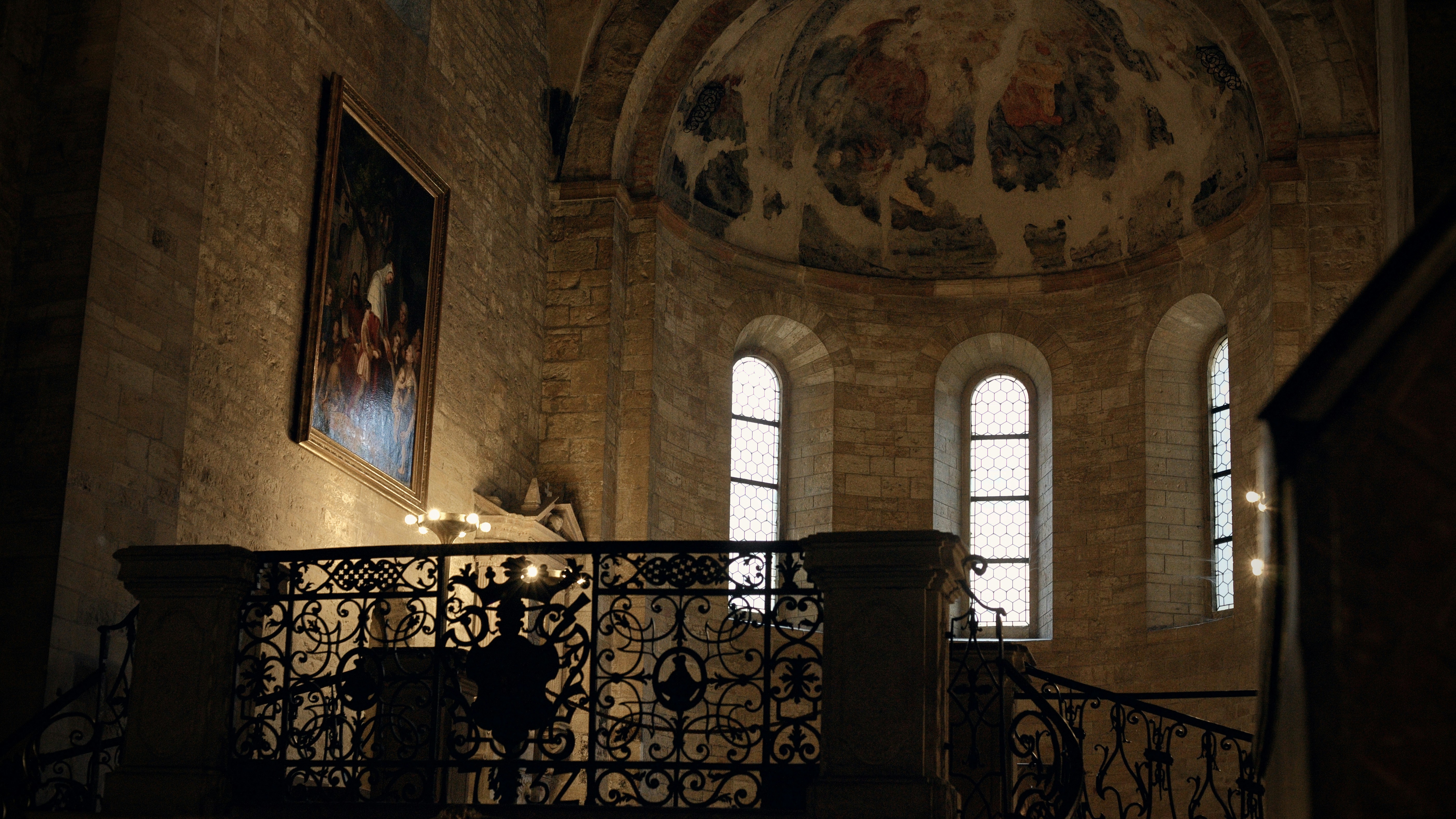 Hushed Nave: Light Through Arched Windows Over The Ornate Rails