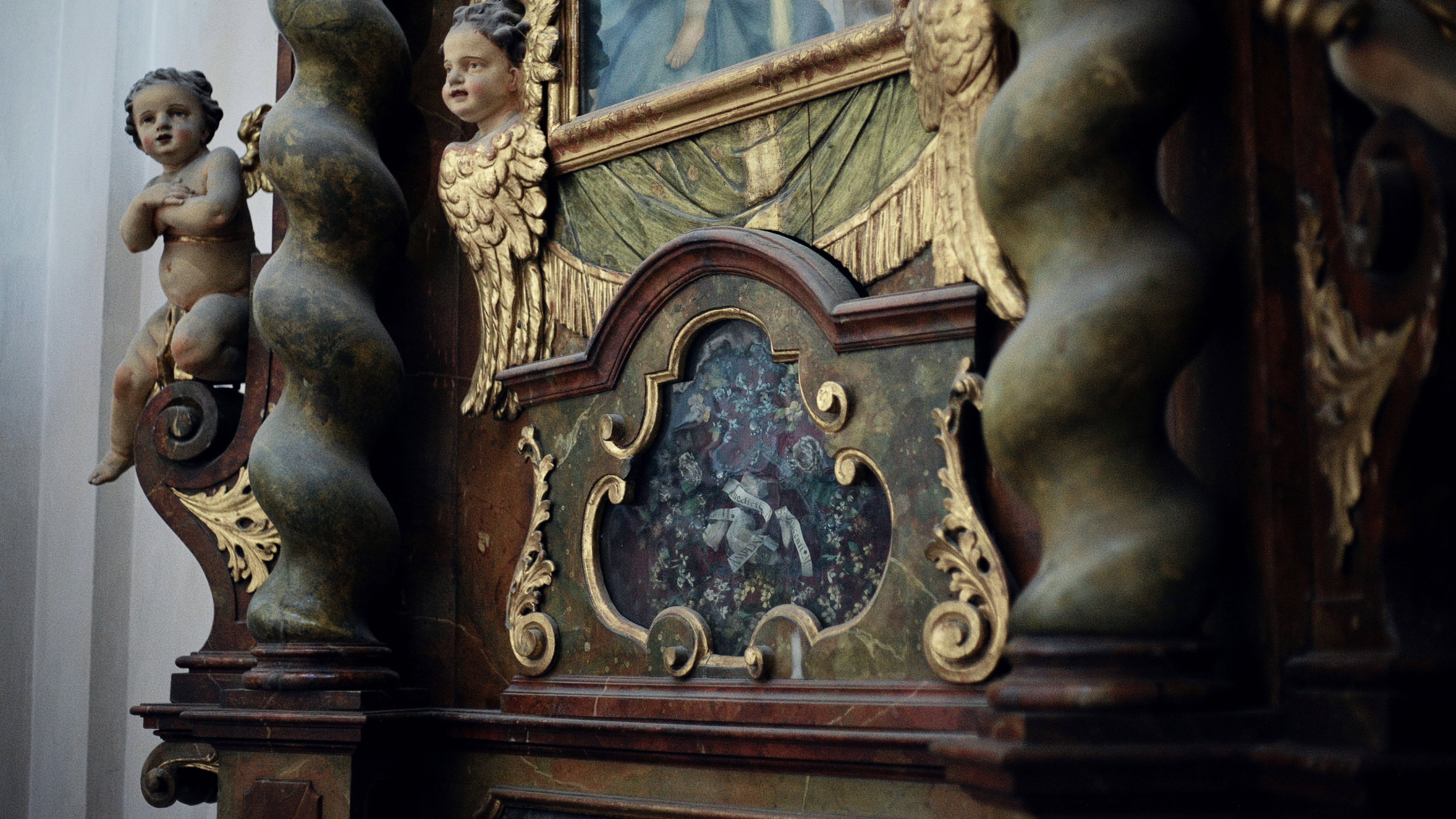 Ornate Sculpted Frame: A Quiet Moment Among Carved Figures