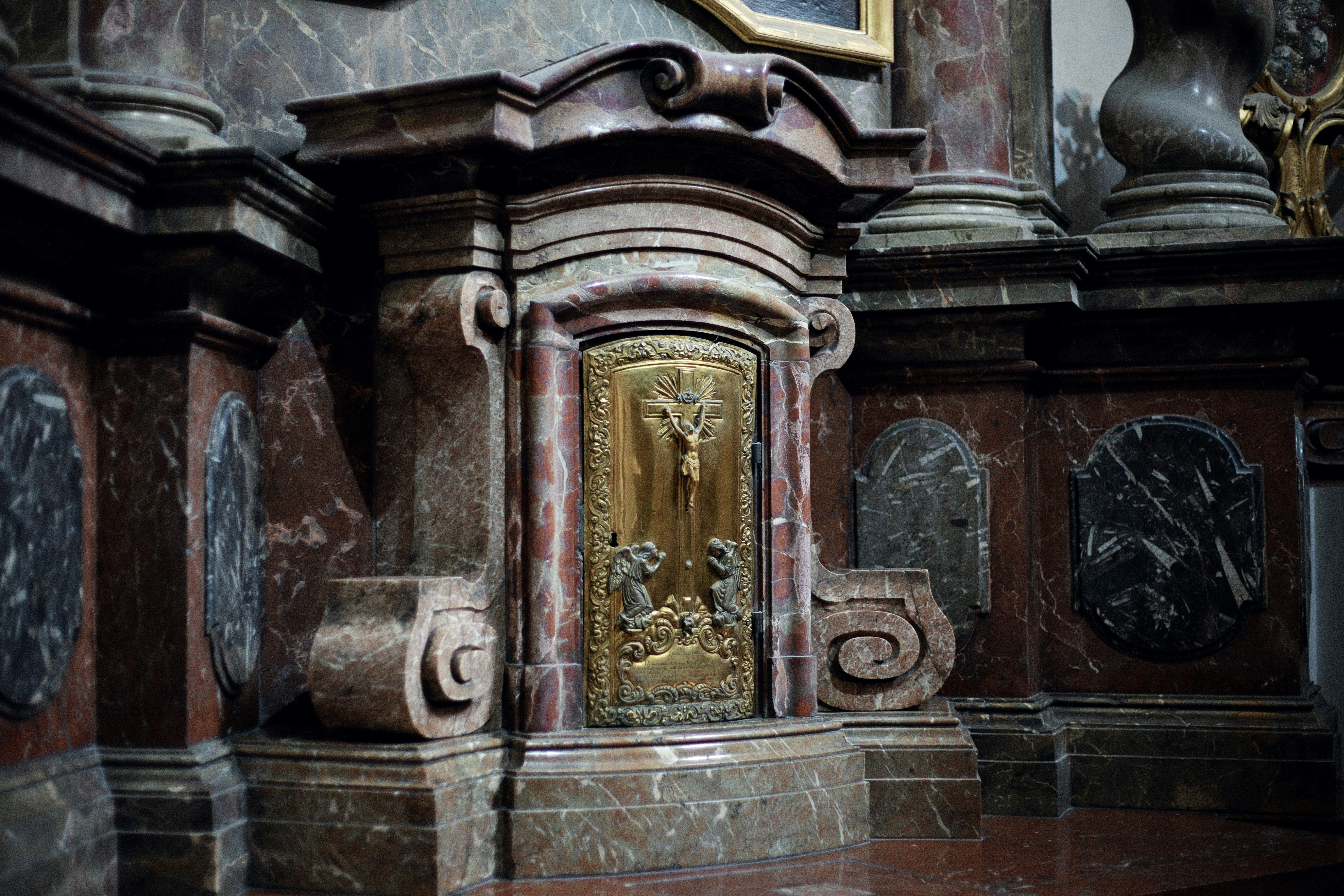 Golden altar relief framed by marble grandeur
