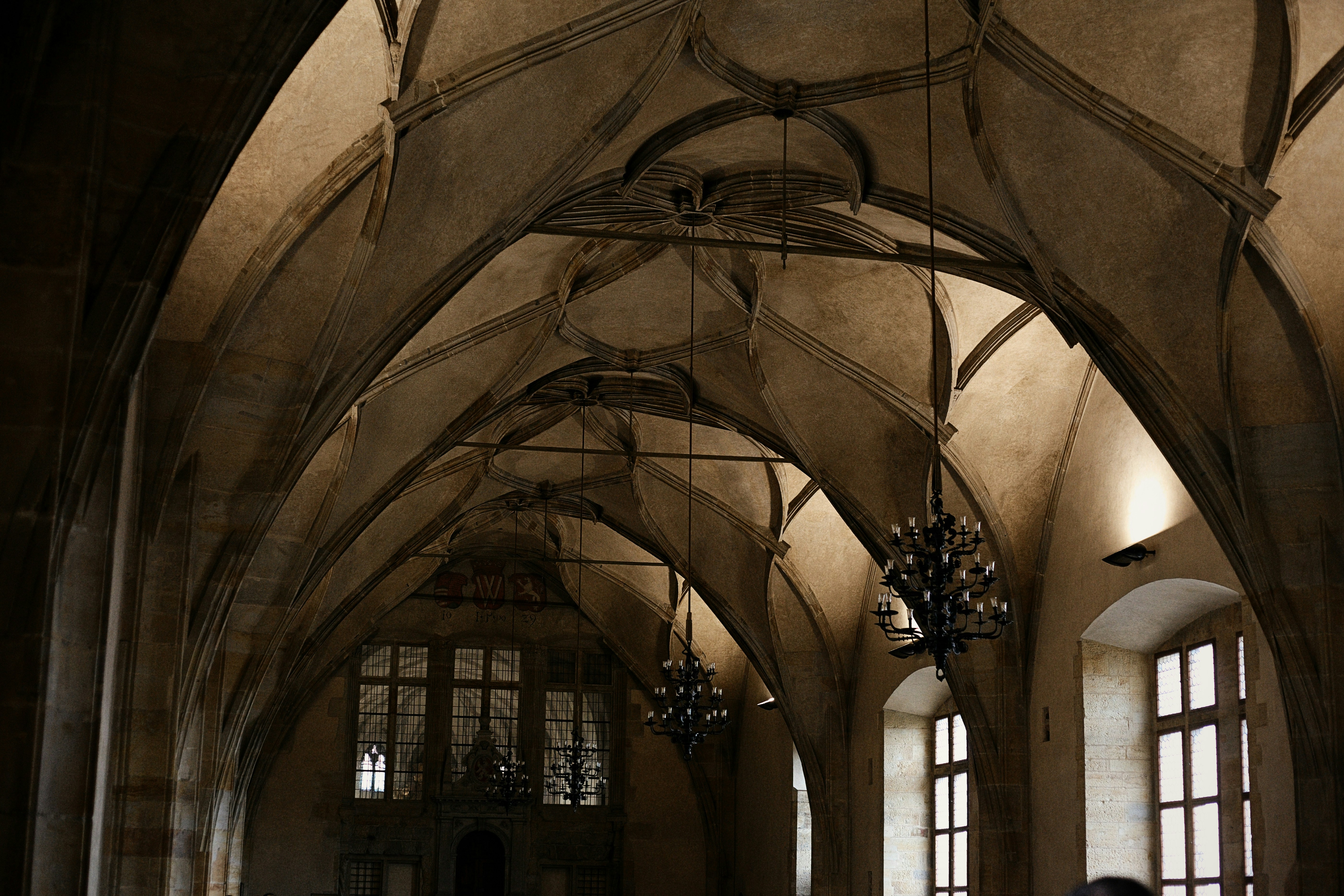 Vaulted Silence: Arches and Chandeliers in Low Light