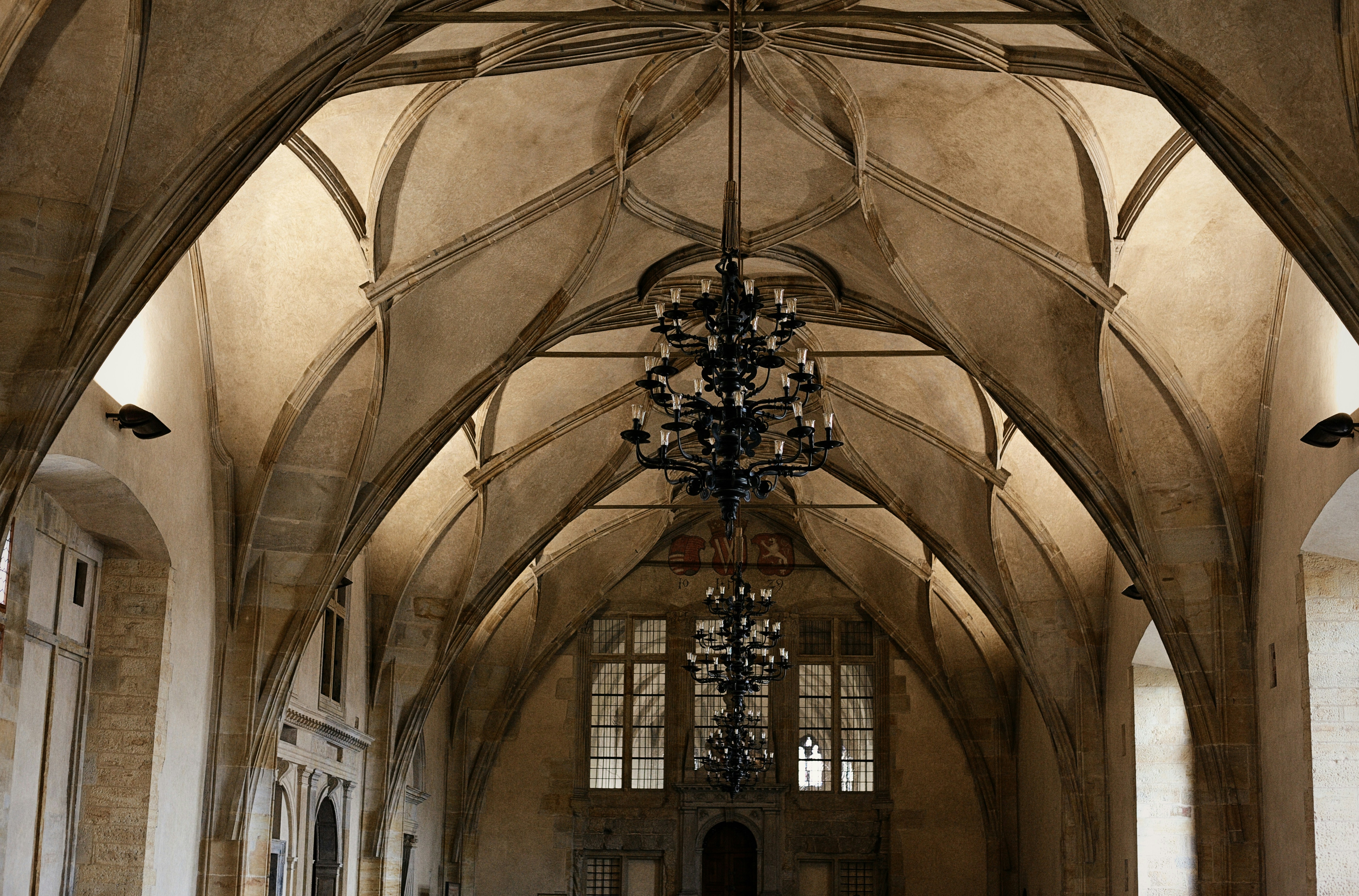 Vaulted Cathedral Hall: Chandeliers Striking Against Arched Ceilings