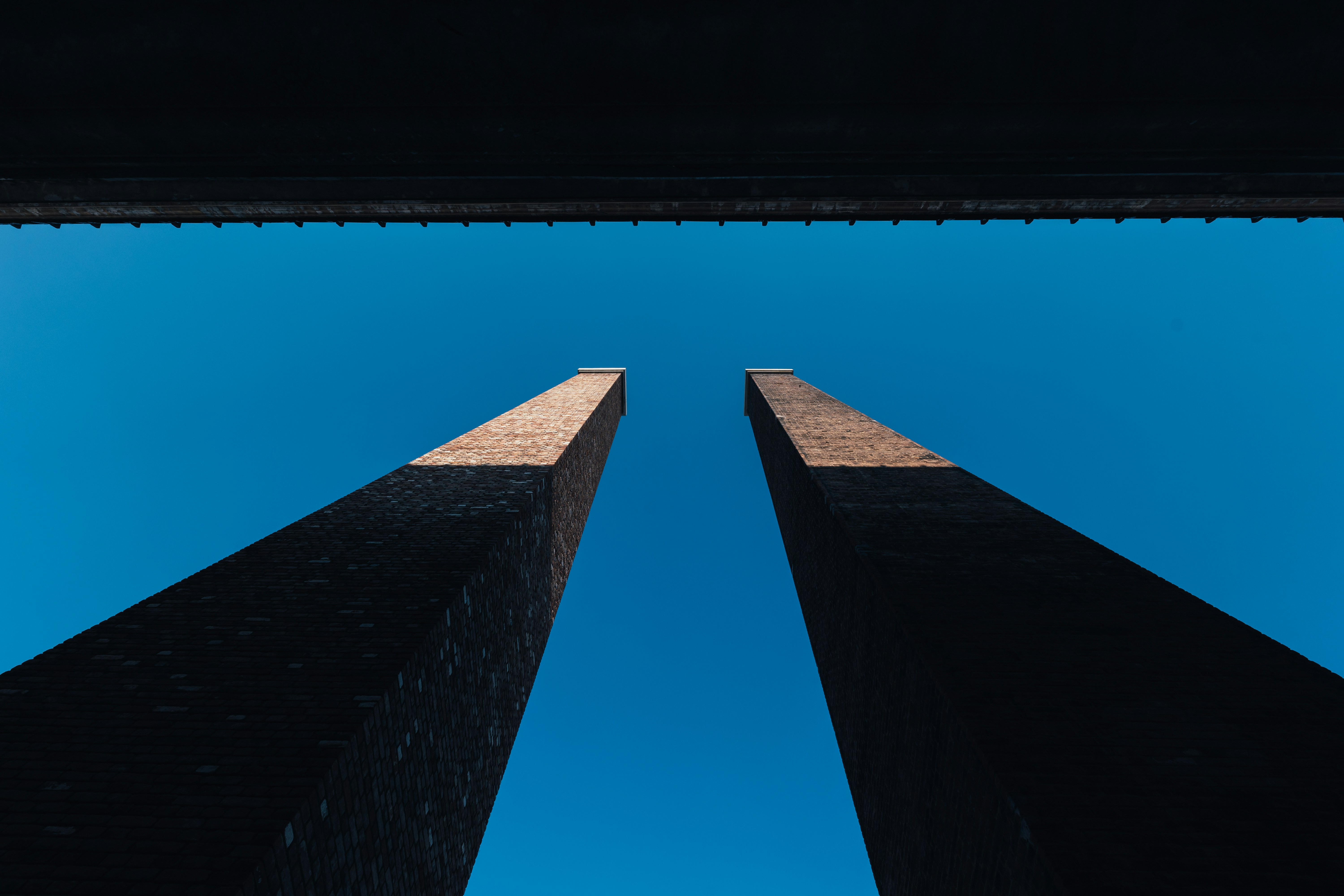 Skyward Gaze Between Monolithic Pillars