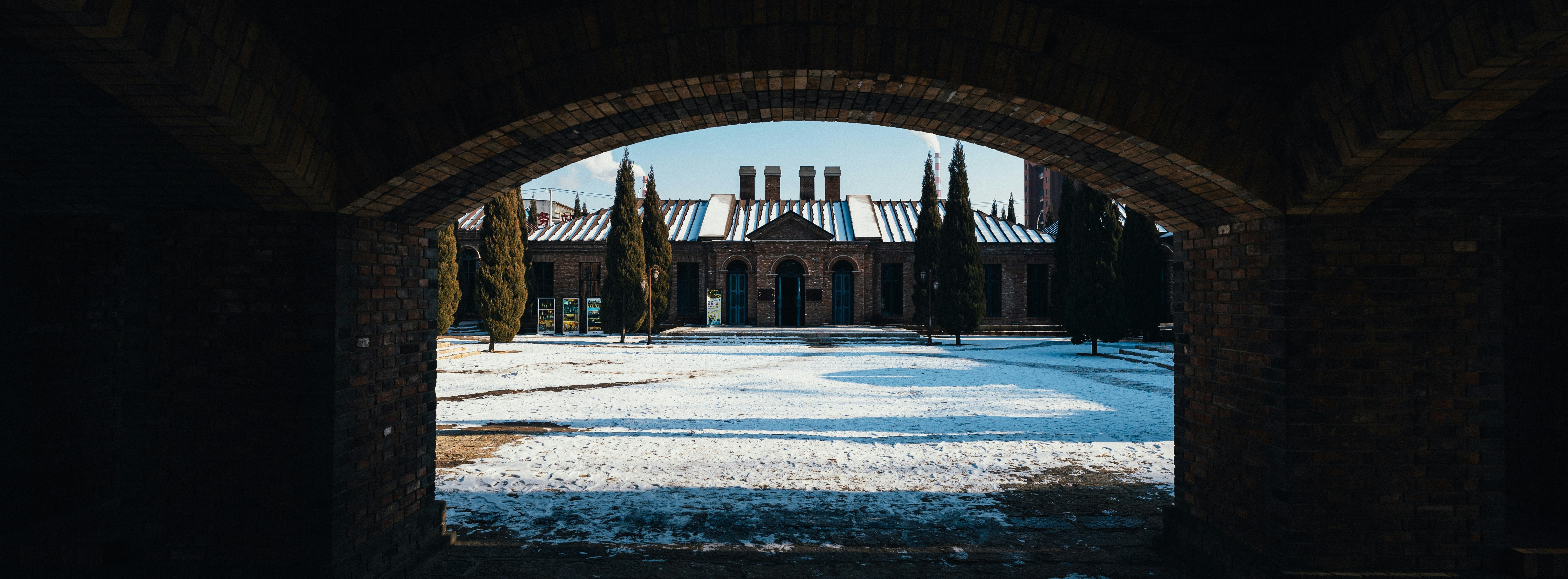 Arched Frame toward a Snow-White Courtyard