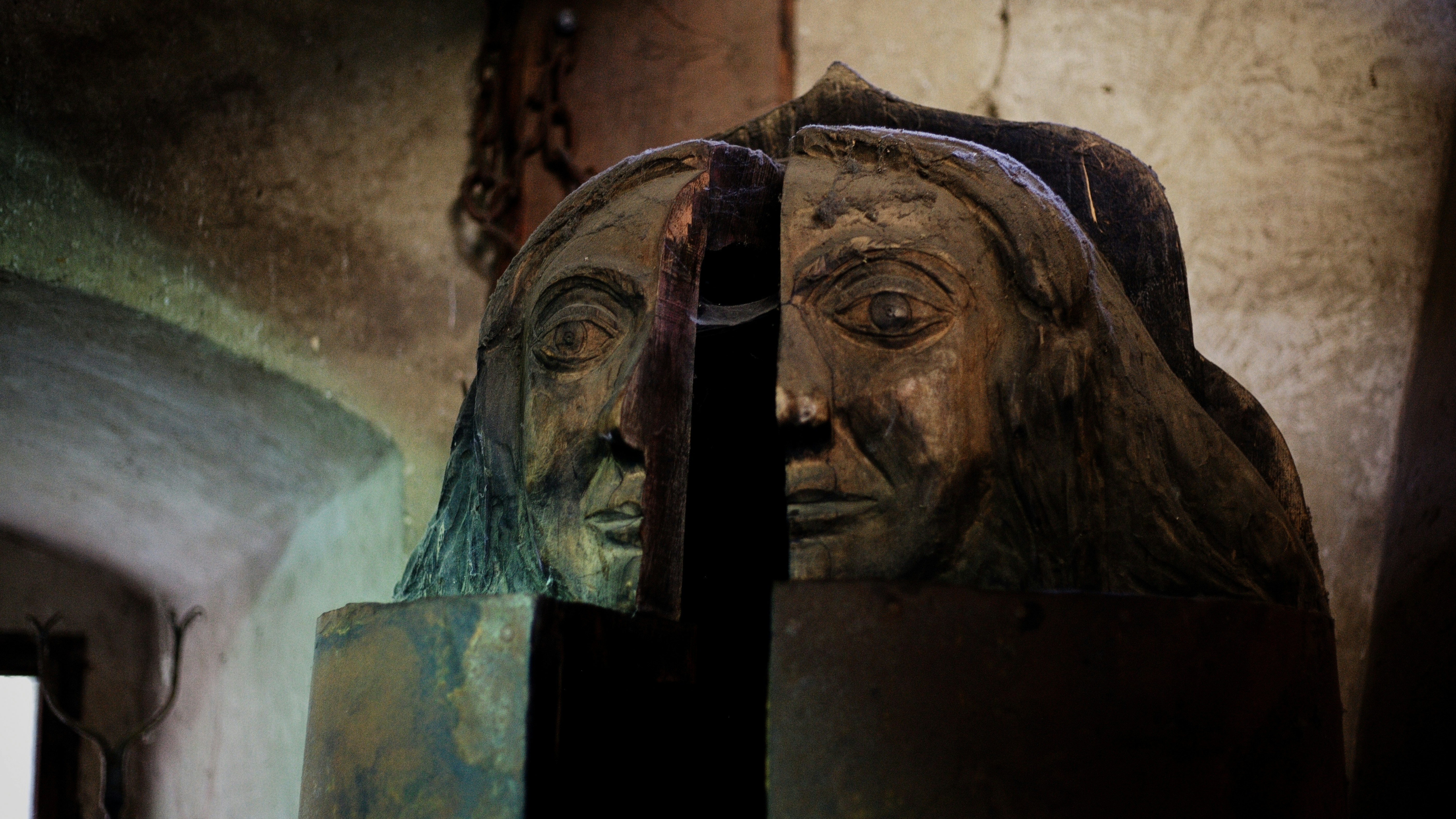 Split Faces in Stone: A Quiet, Fragmented Portrait