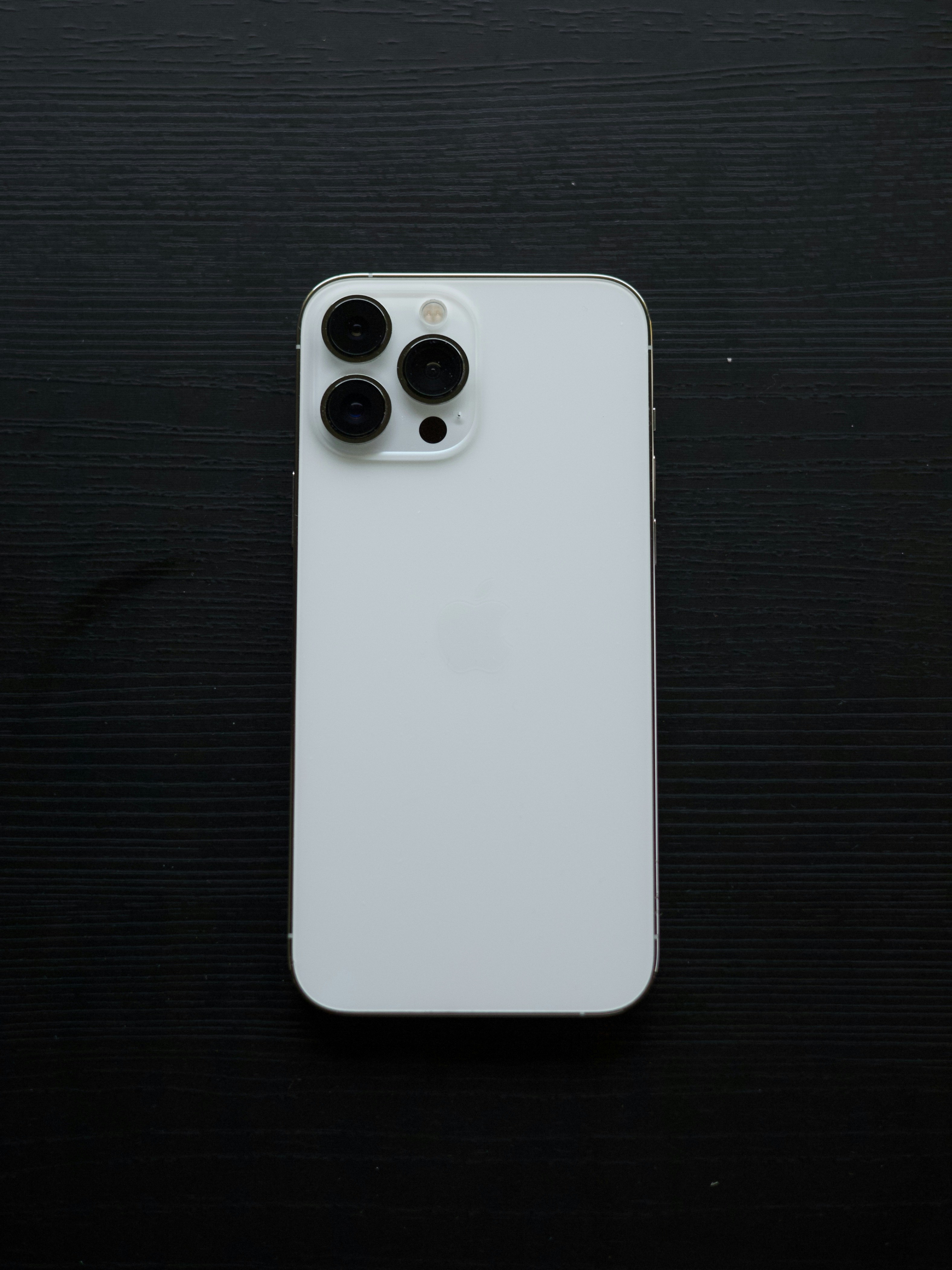 Minimalist White iPhone on Dark Soffit: A Close-Contrast Still Life