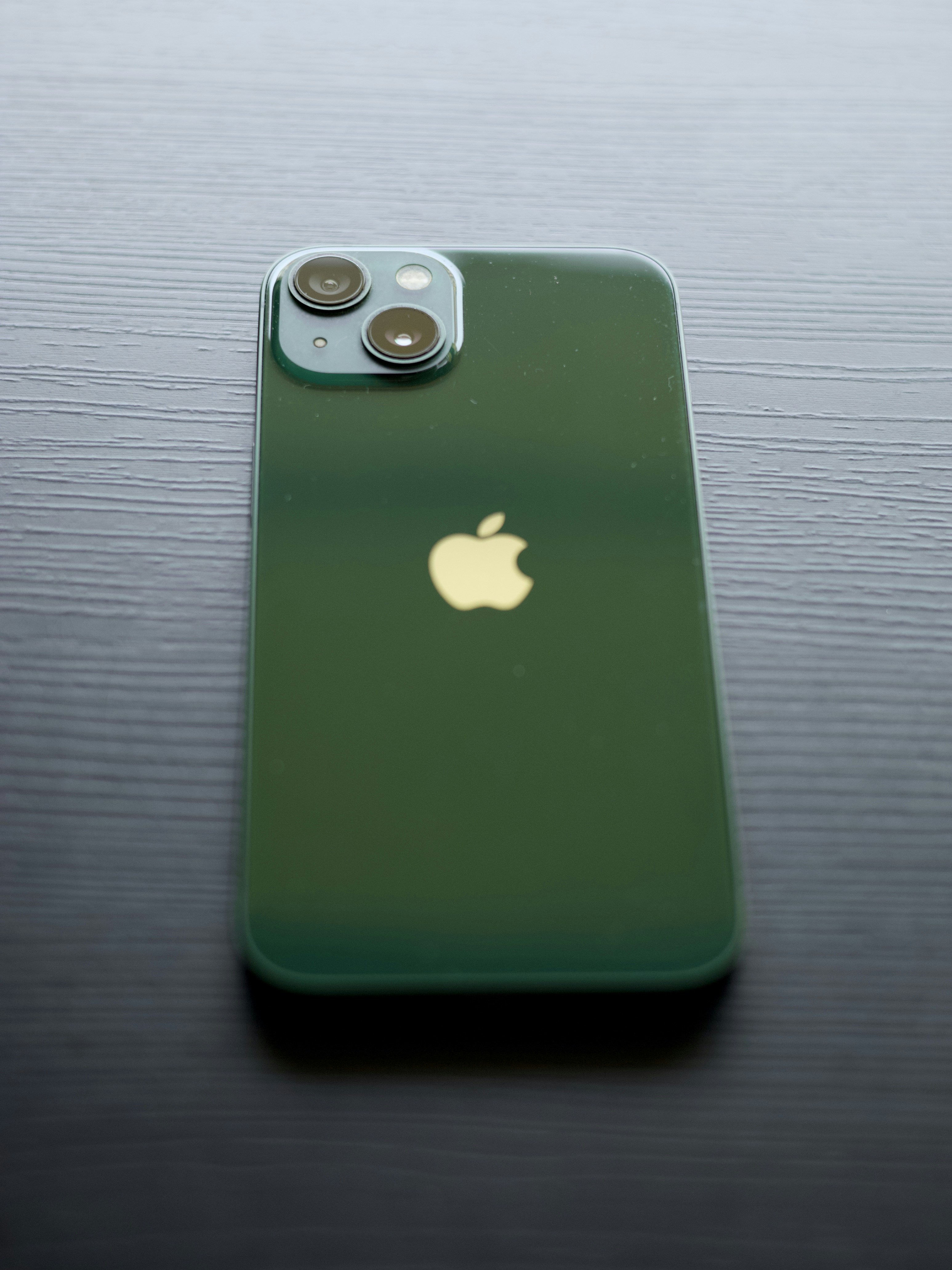 Emerald Back: A Green iPhone Quietly Resting on Textured Surface