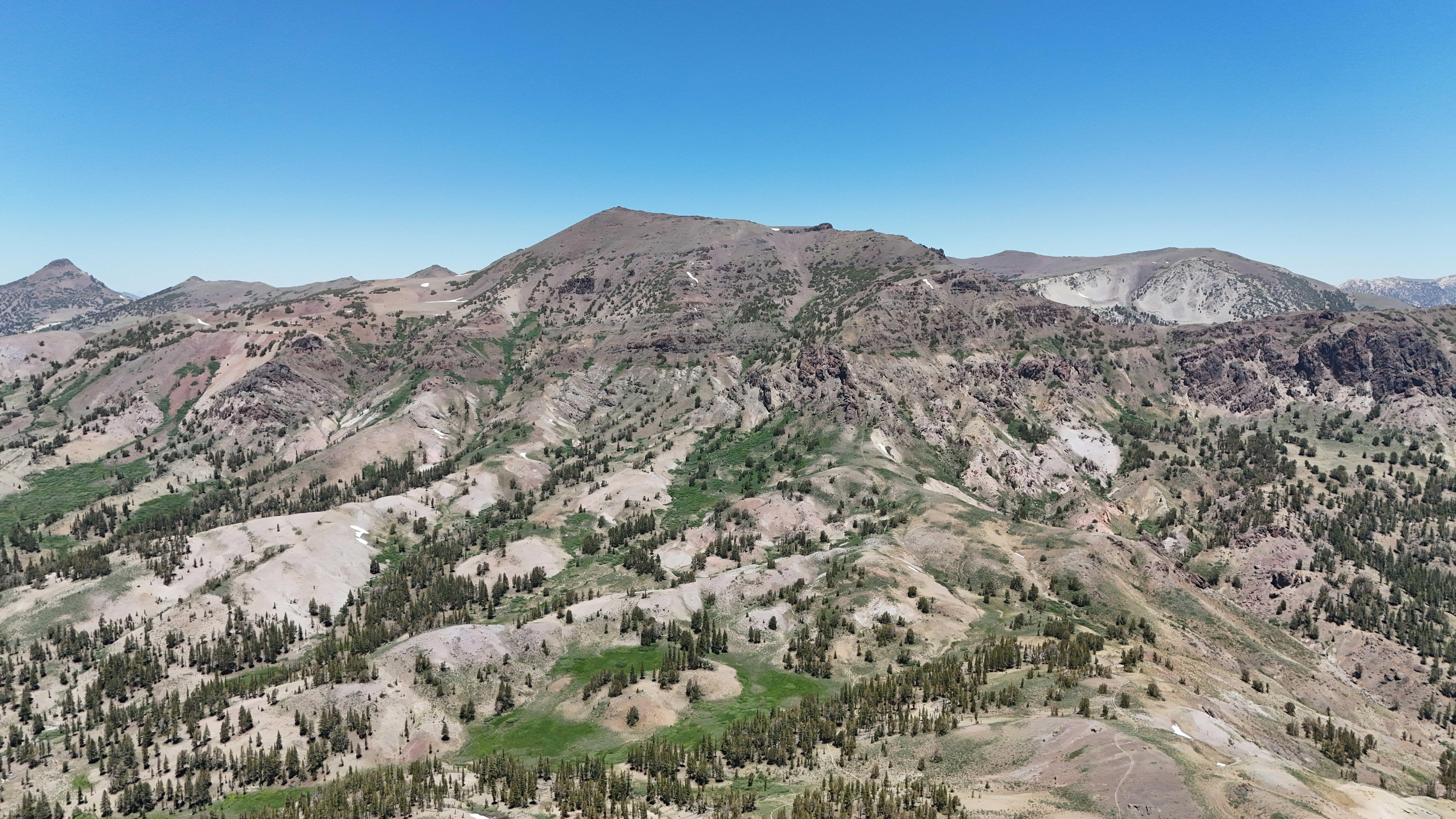 Rugged Crest Above Desert Pines Under A Clear Blue Sky