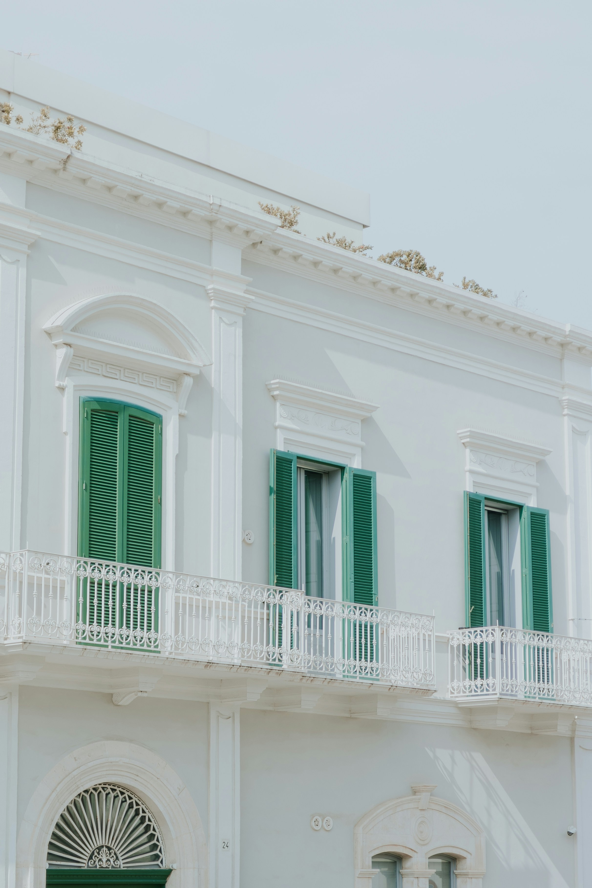 Teal Shutters in Sunlit Facade