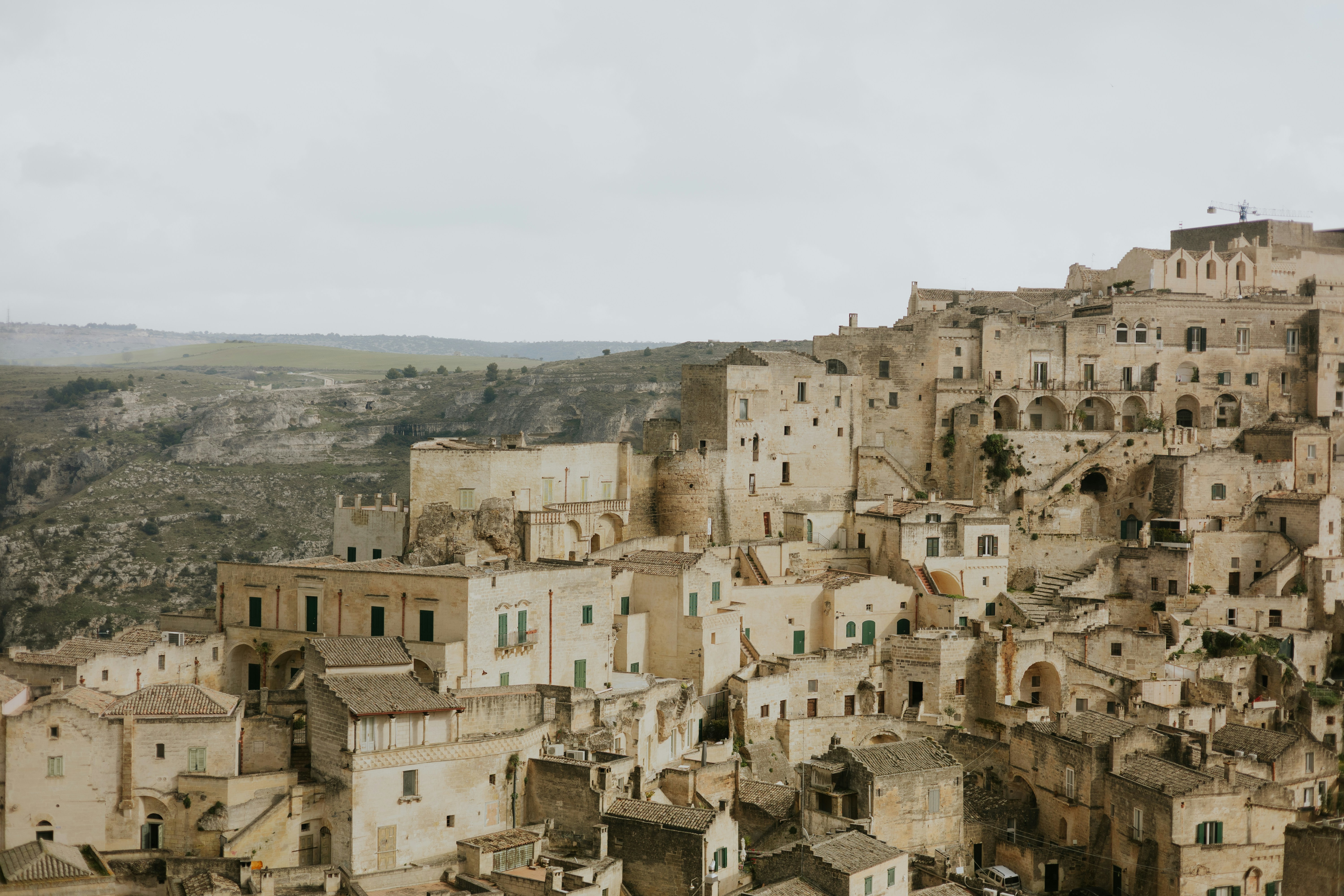 Sunlit Limestone Village Clad in Quiet Geometry
